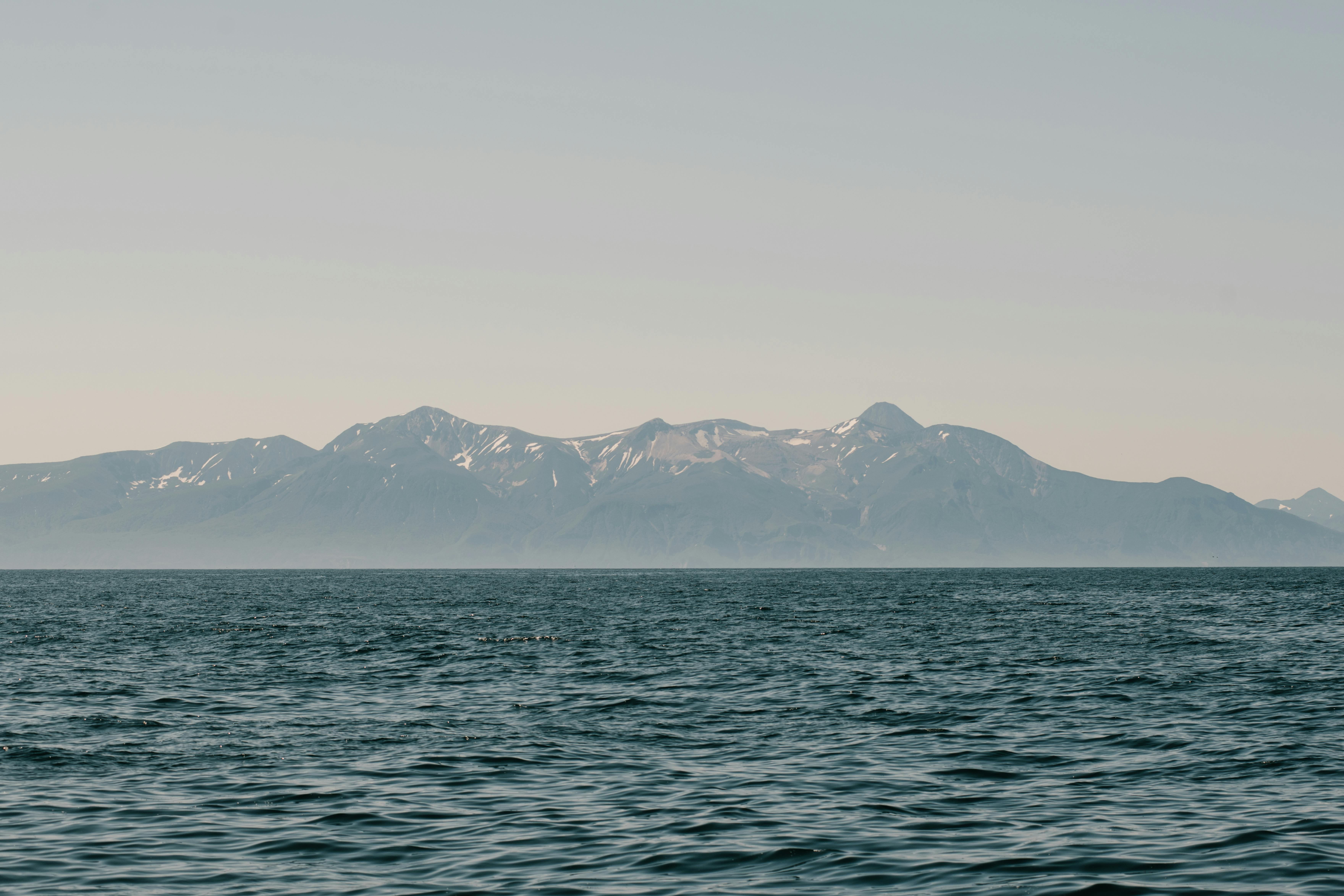 Body of Water Near Mountain · Free Stock Photo