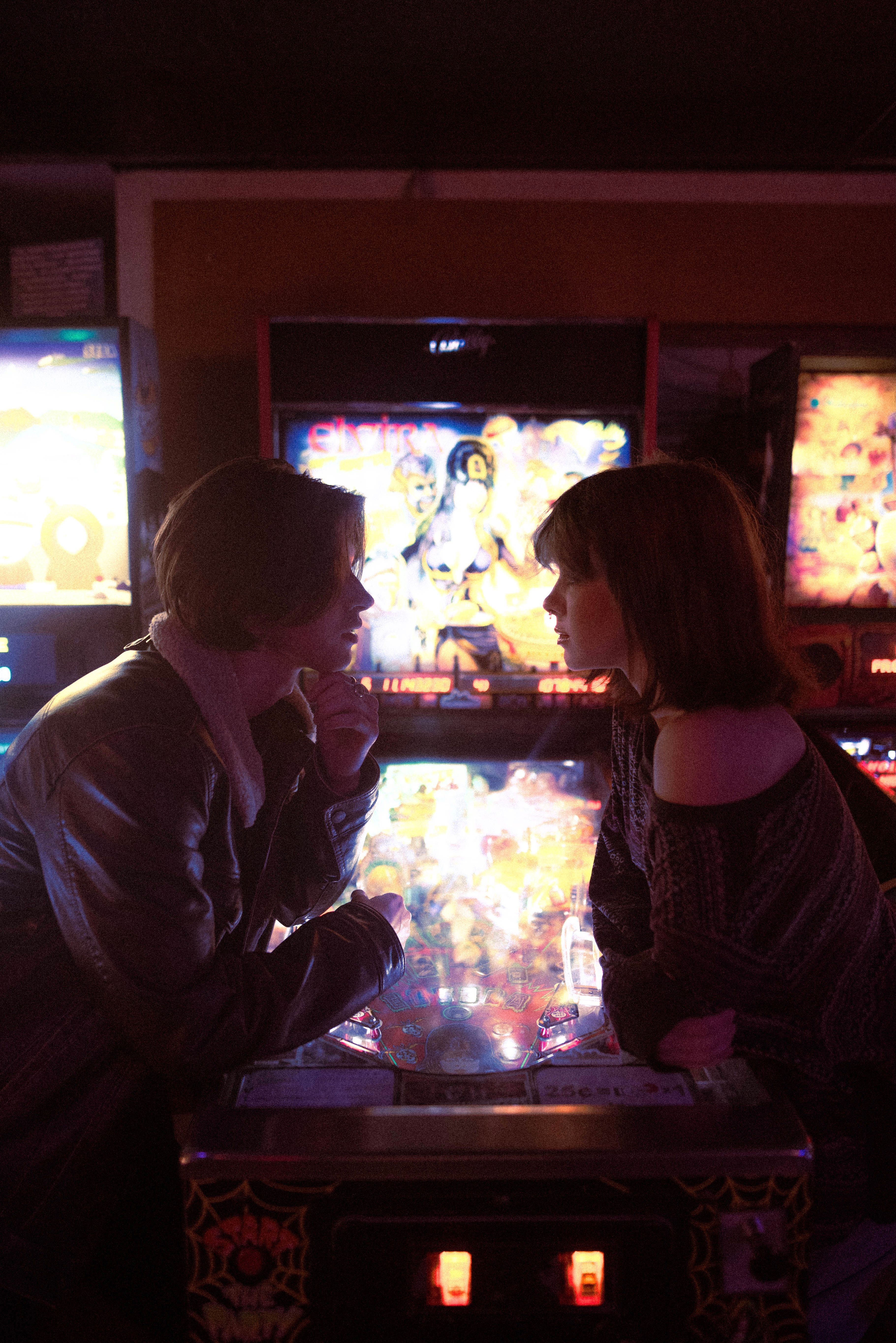 A Couple Sitting at the Arcade Games Seats · Free Stock Photo