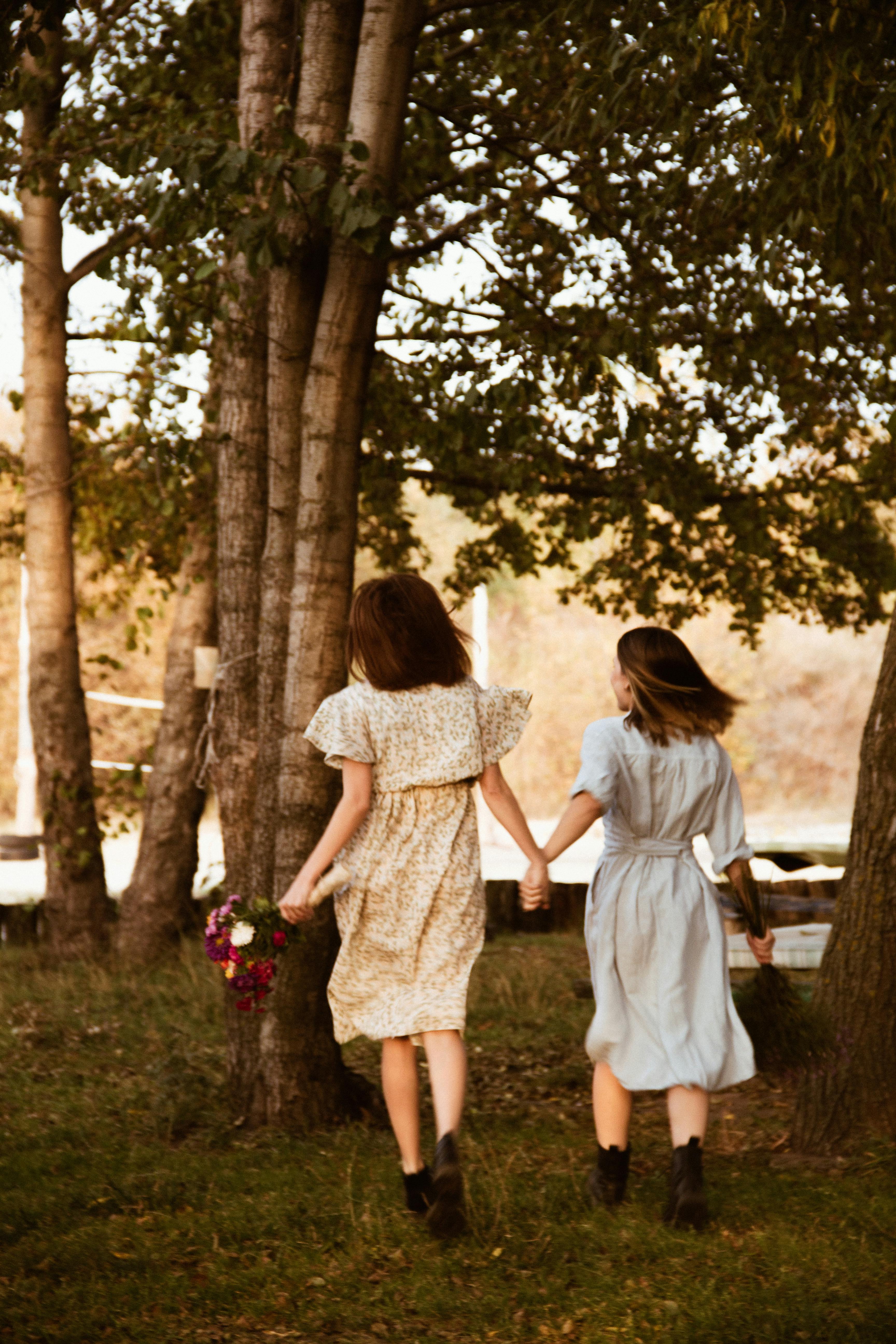 Women Holding Hands while Walking · Free Stock Photo