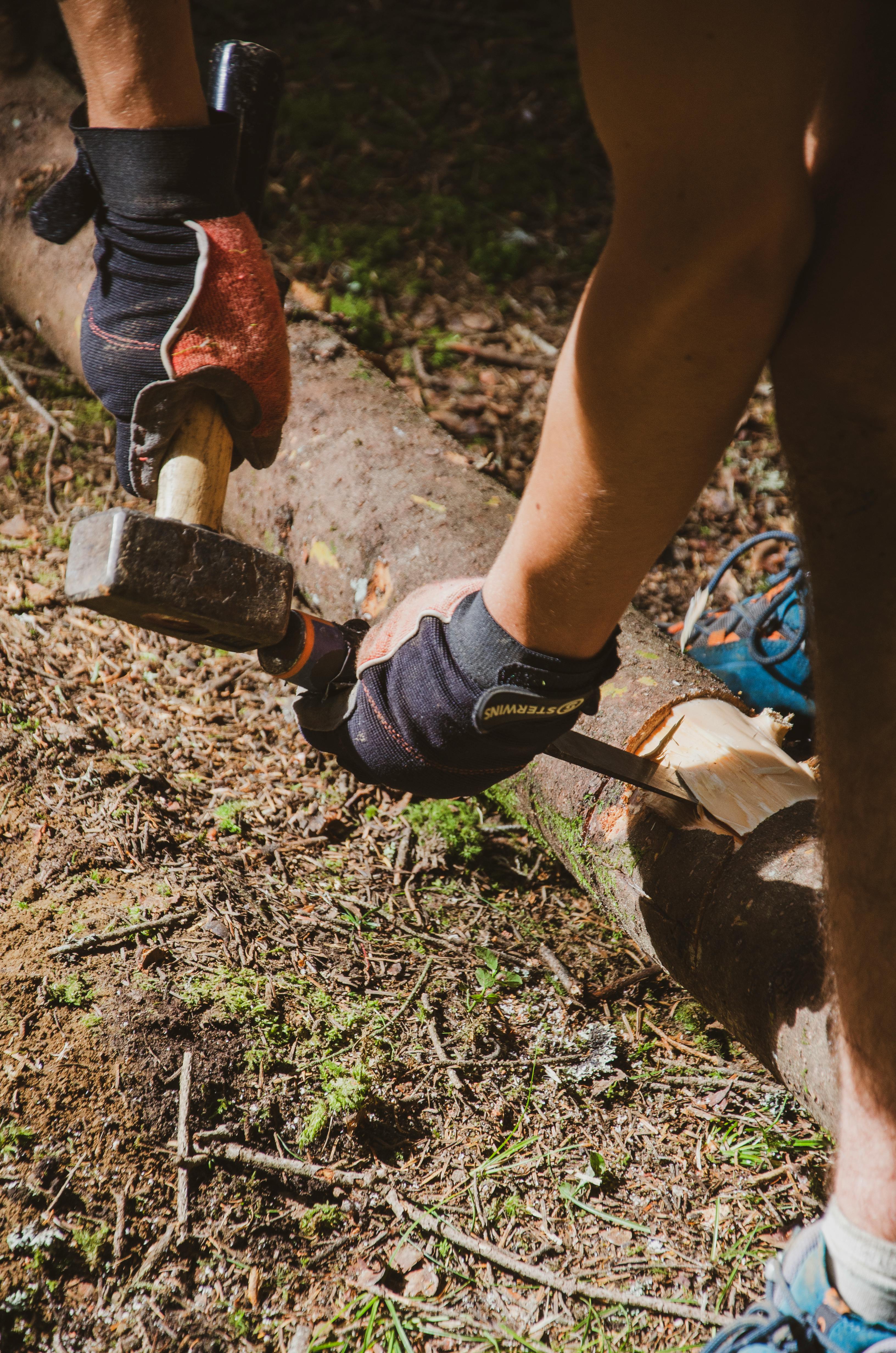 A Person Using a Chisel and a Hammer · Free Stock Photo