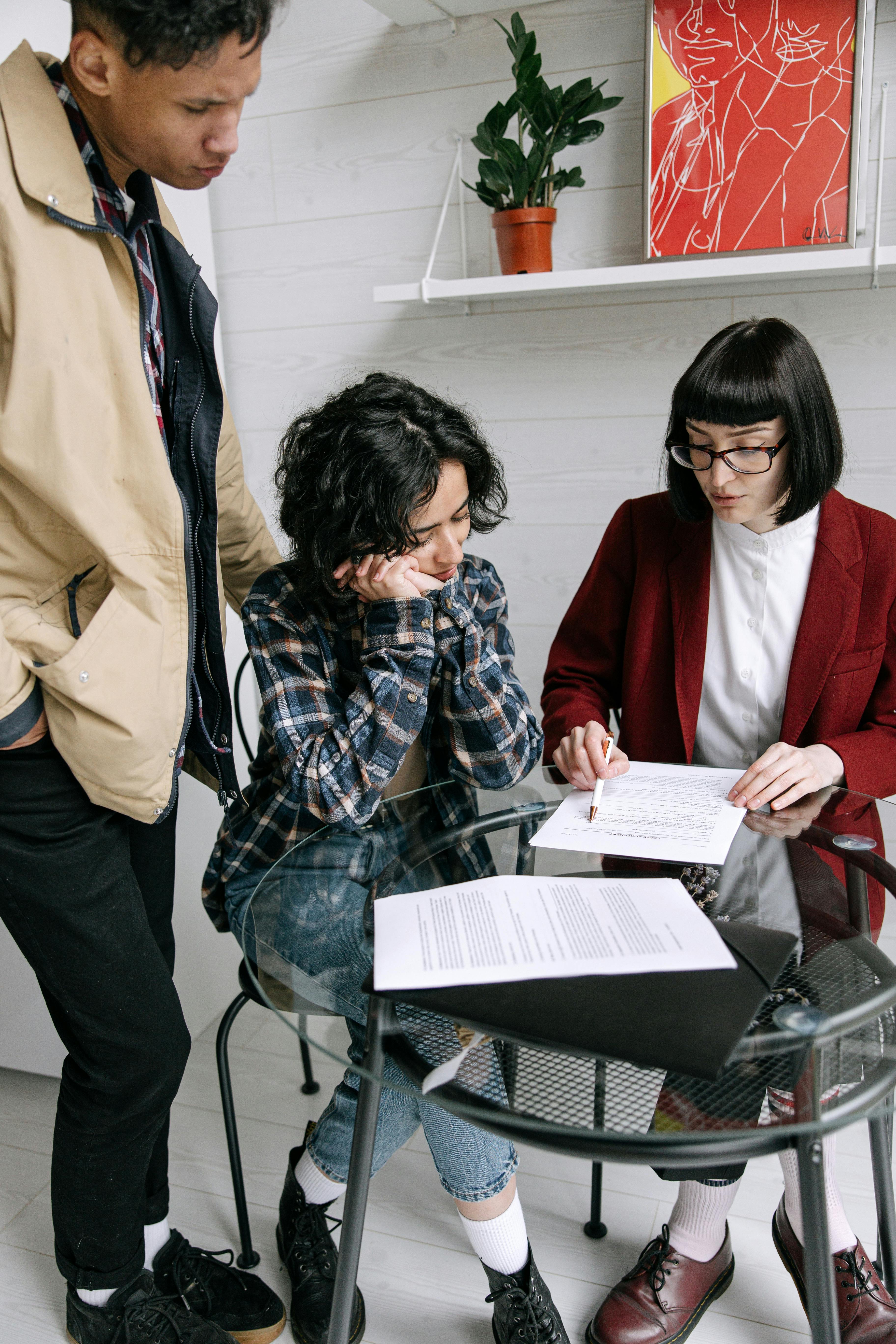 An Agent Showing the Documents to Her Client · Free Stock Photo