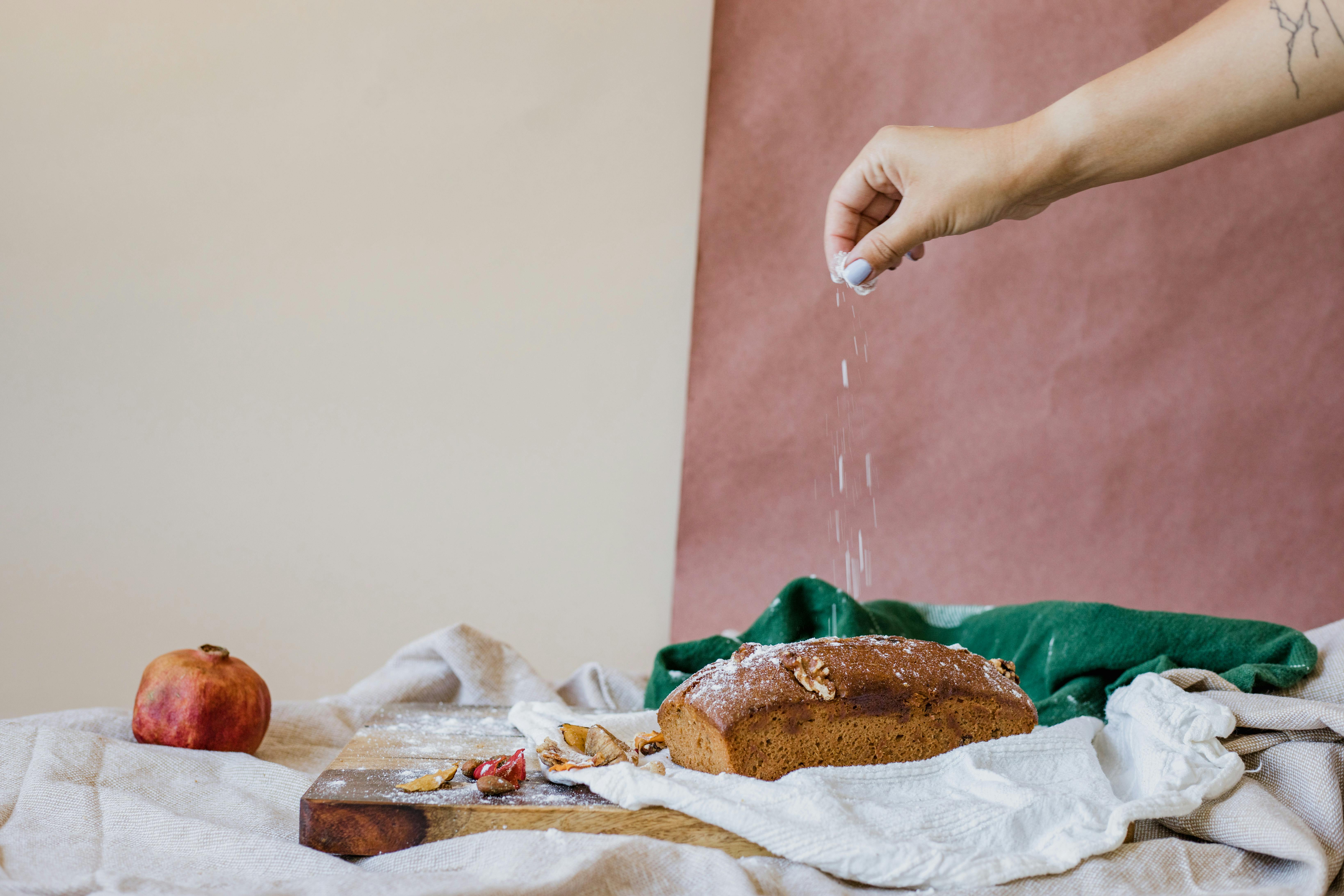 Woman Sprinkling Bread with Flour · Free Stock Photo