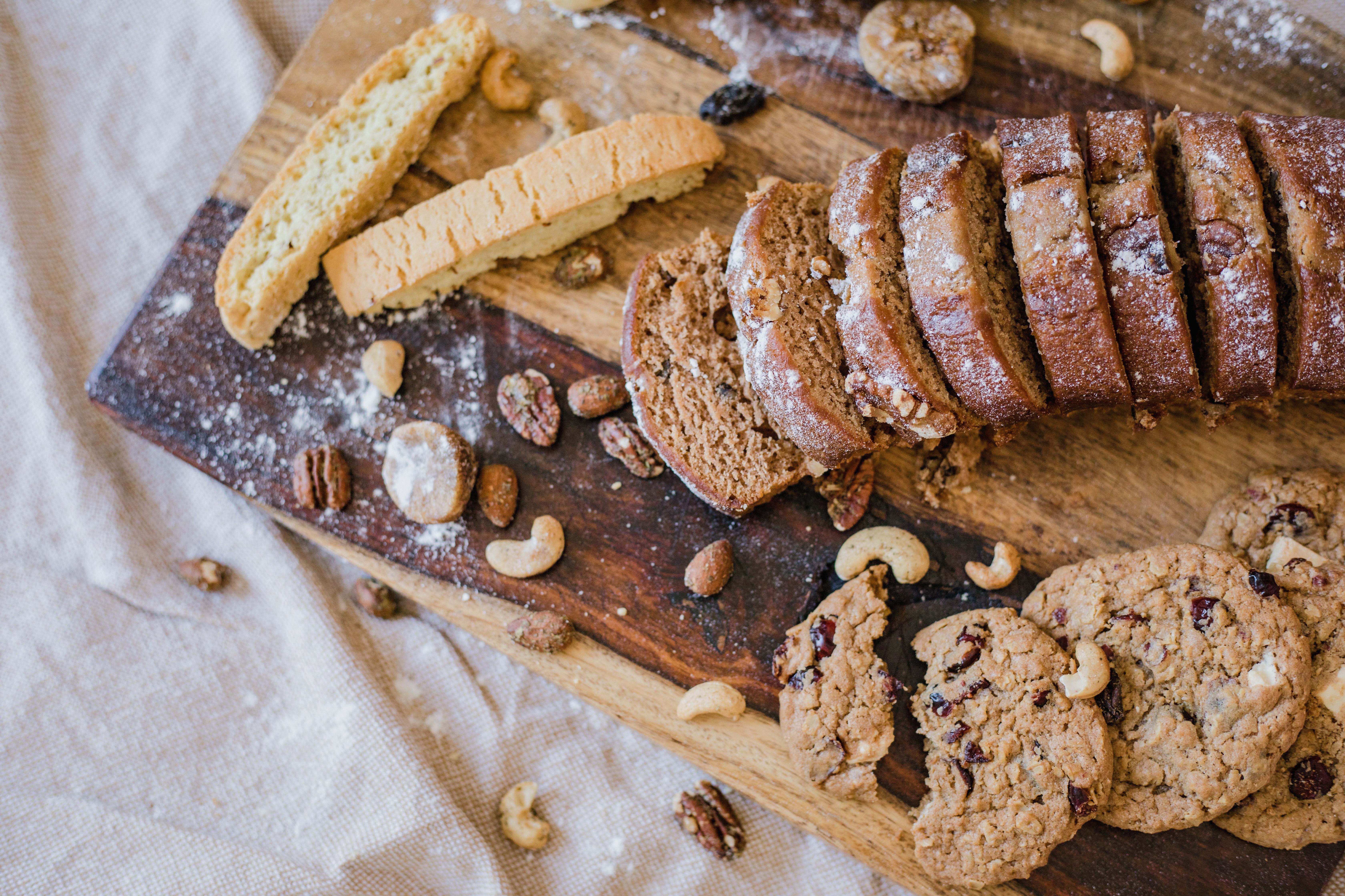 Close-Up Shot of Cookies and Breads on a Wooden Tray · Free Stock Photo