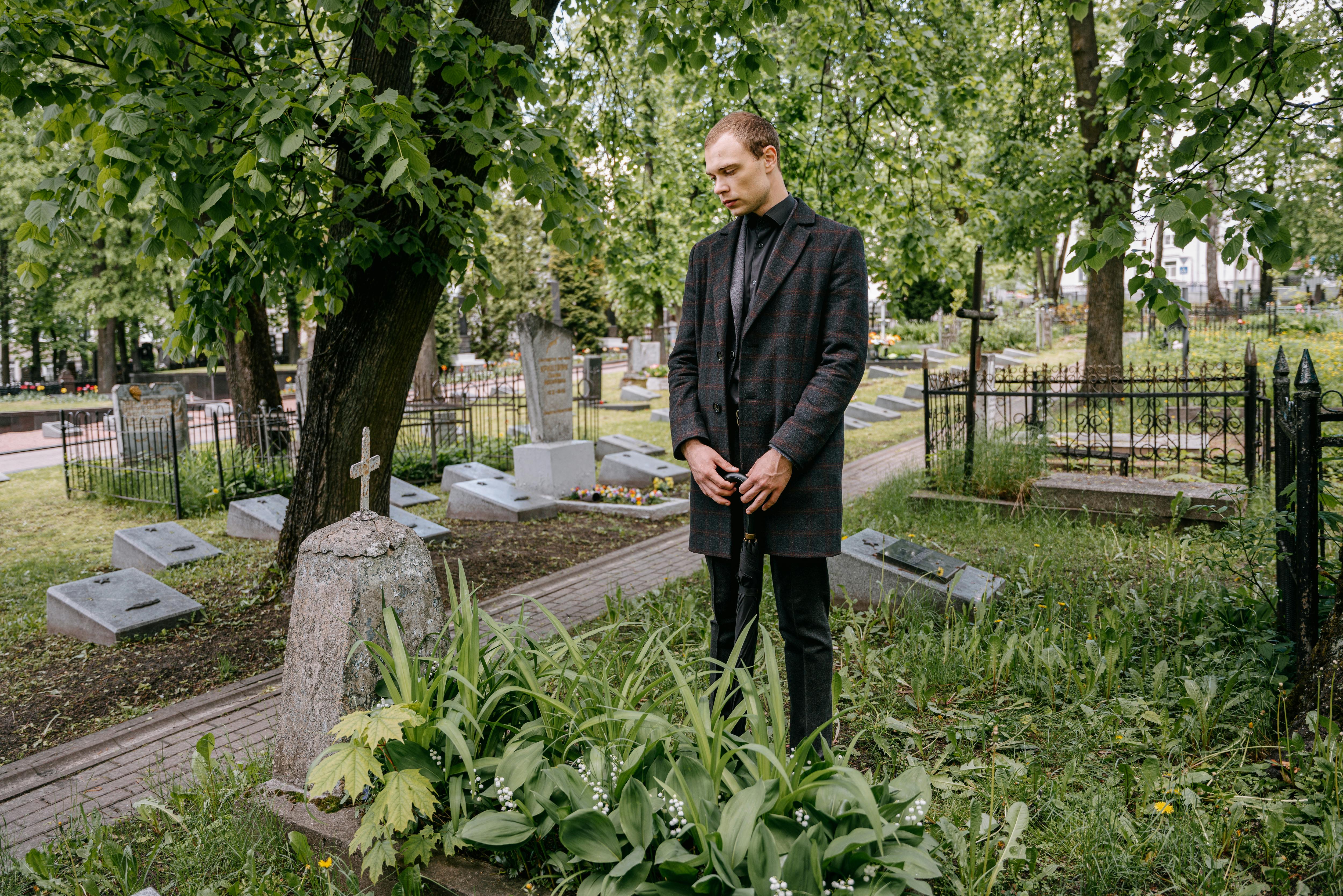 A Man Sitting by a Grave · Free Stock Photo