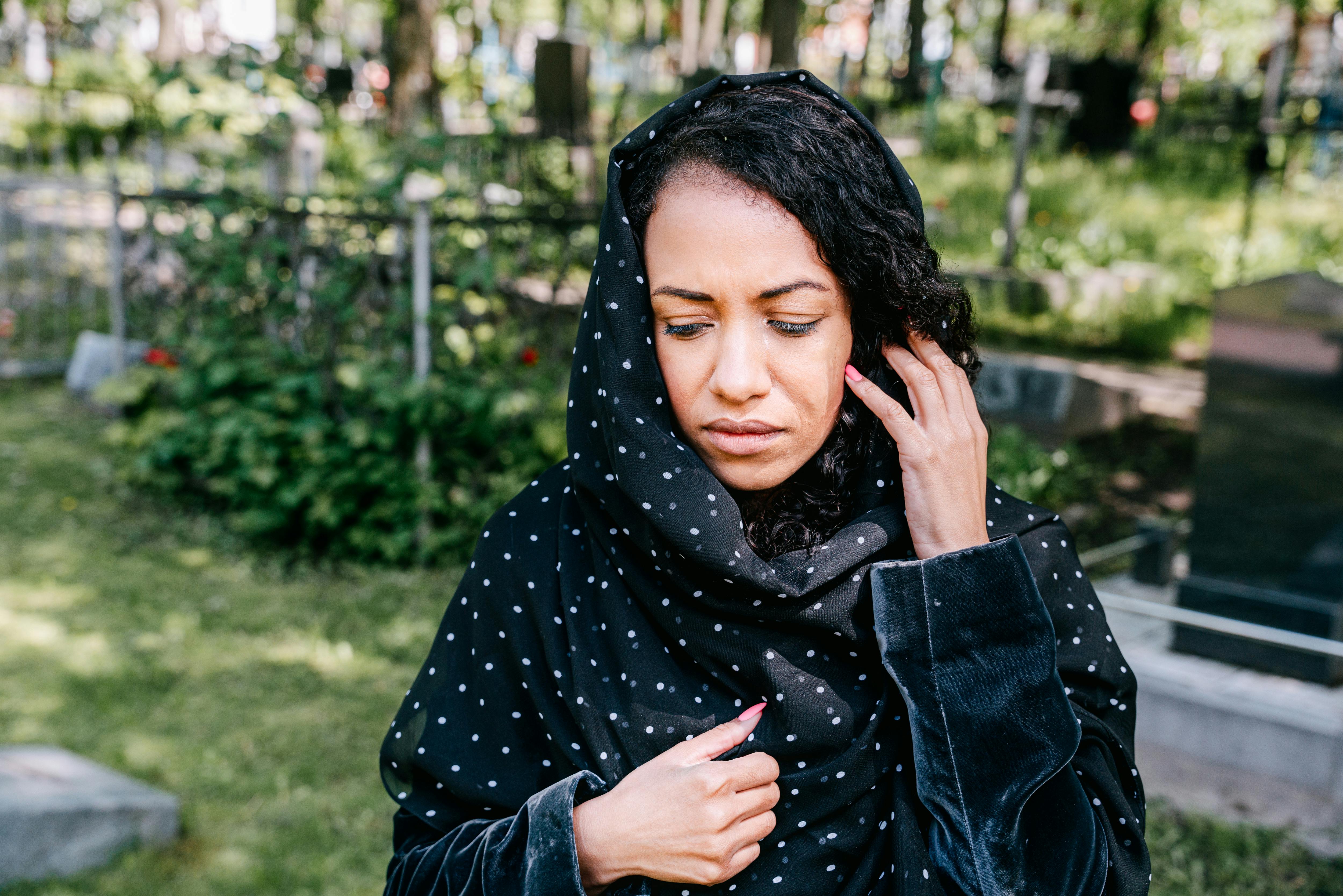A Woman in Black Dress and Headscarf Expressing Grief · Free Stock Photo