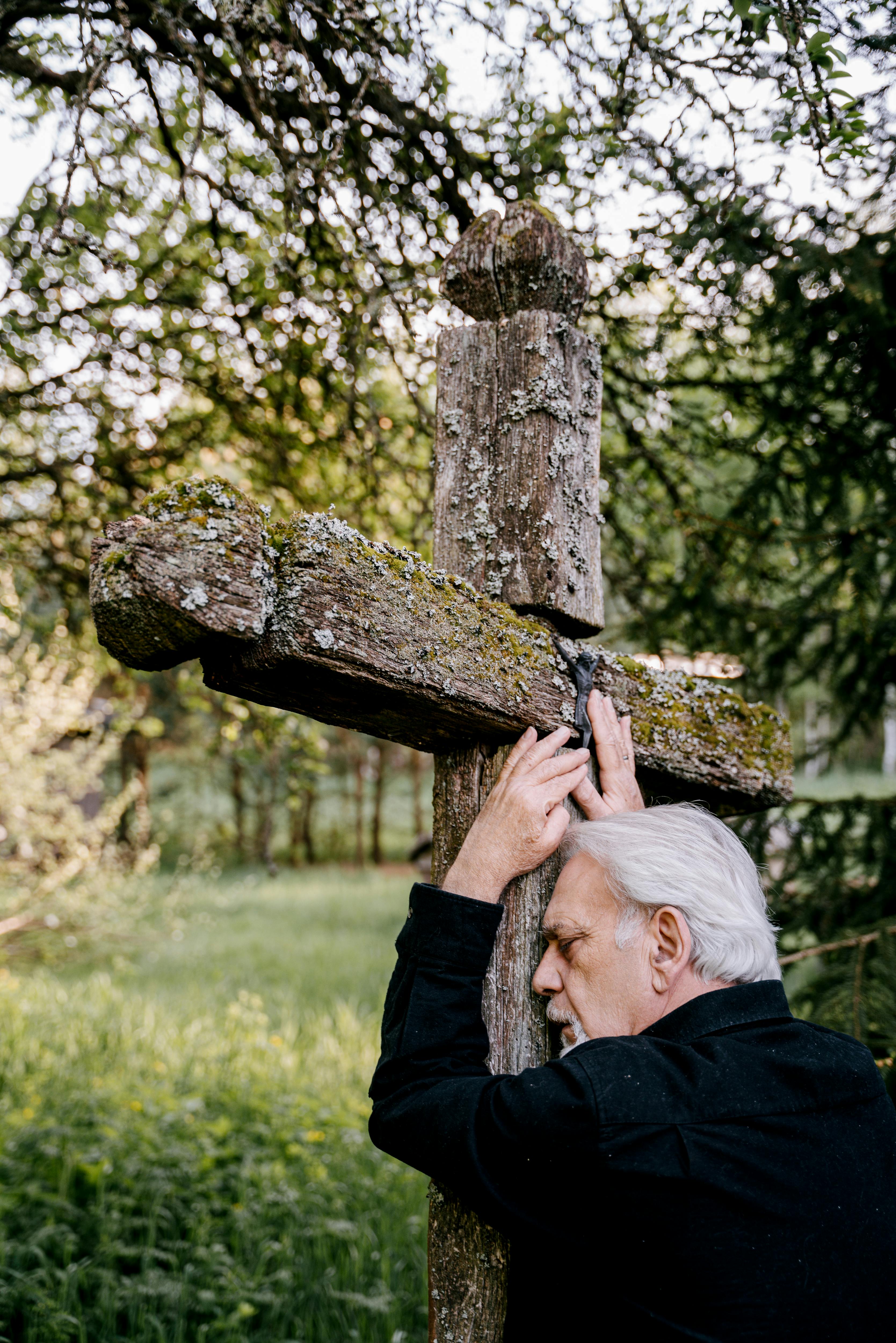 A Man Holding a Cross · Free Stock Photo