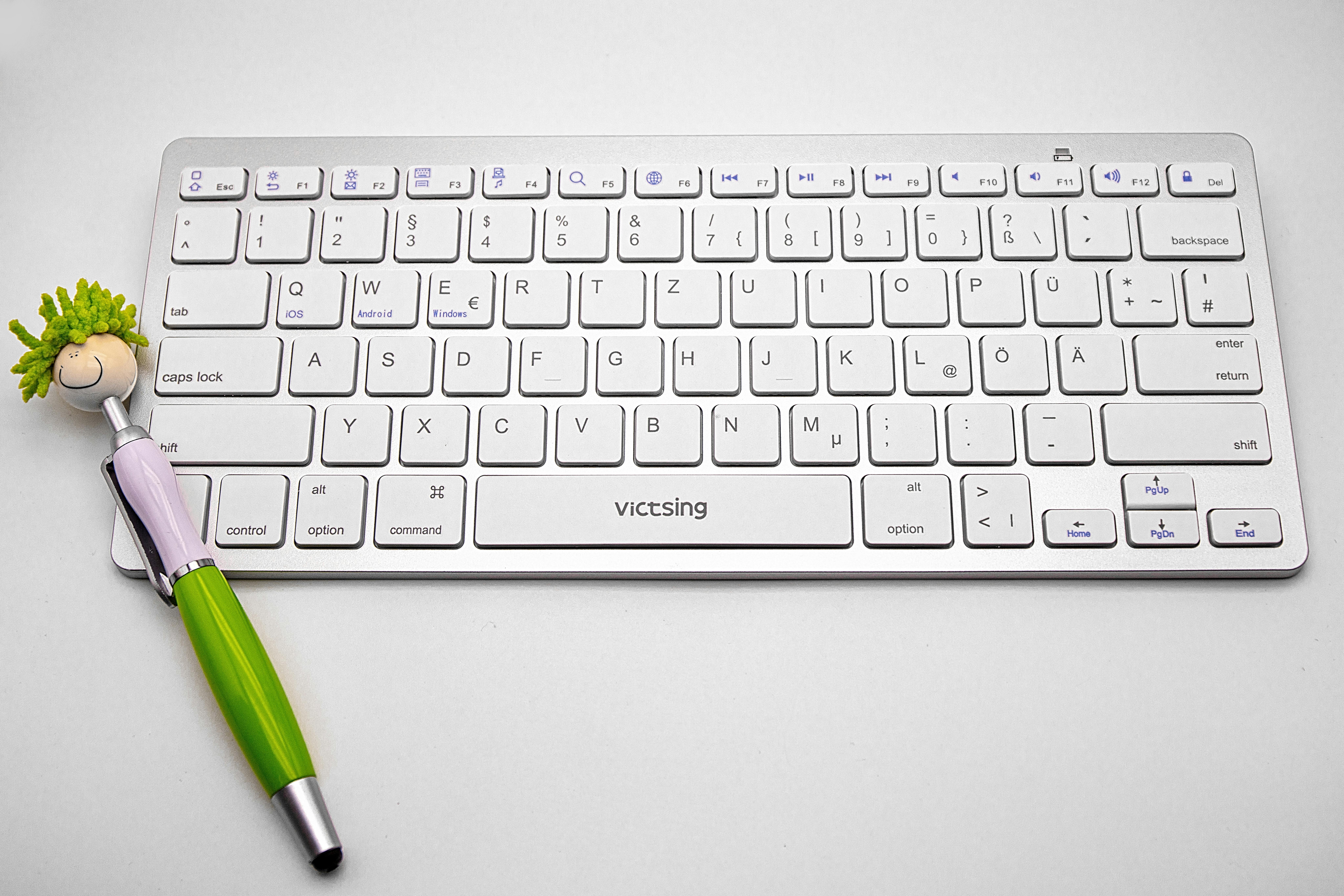 A Keyboard and a Pen on the Table · Free Stock Photo