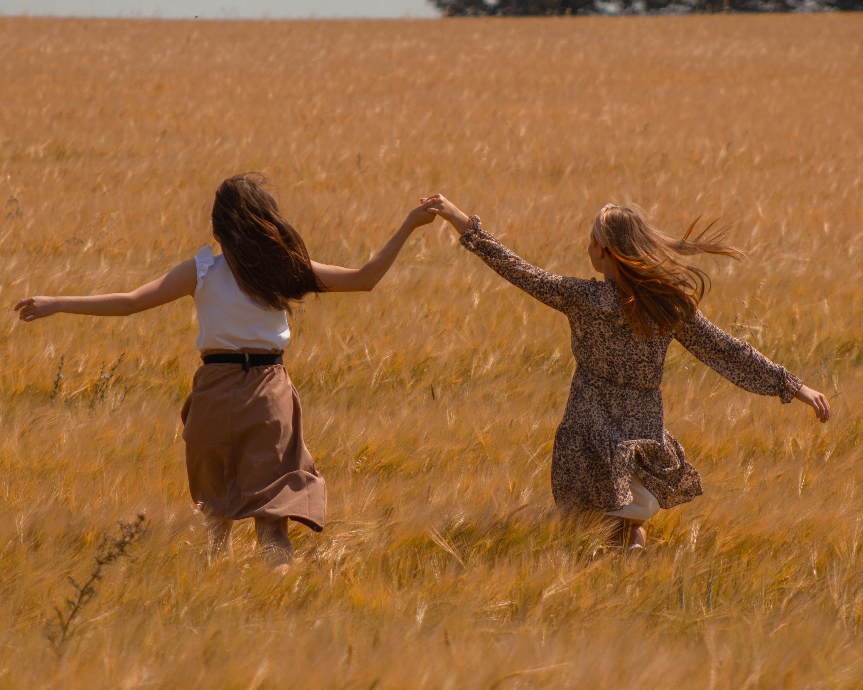 Two Women Running in the Field · Free Stock Photo