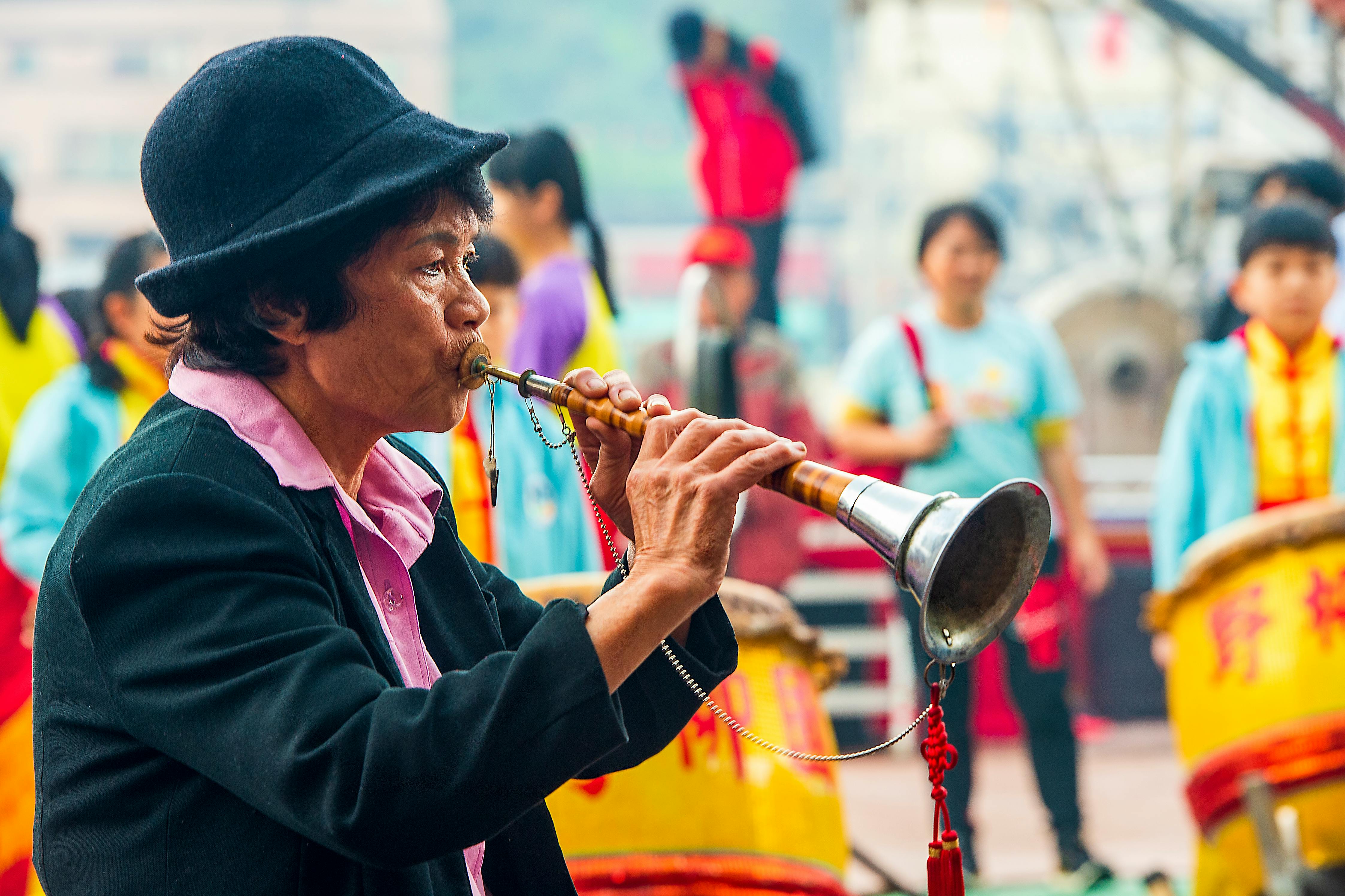 Pretty Woman Playing a Wind Instrument · Free Stock Photo