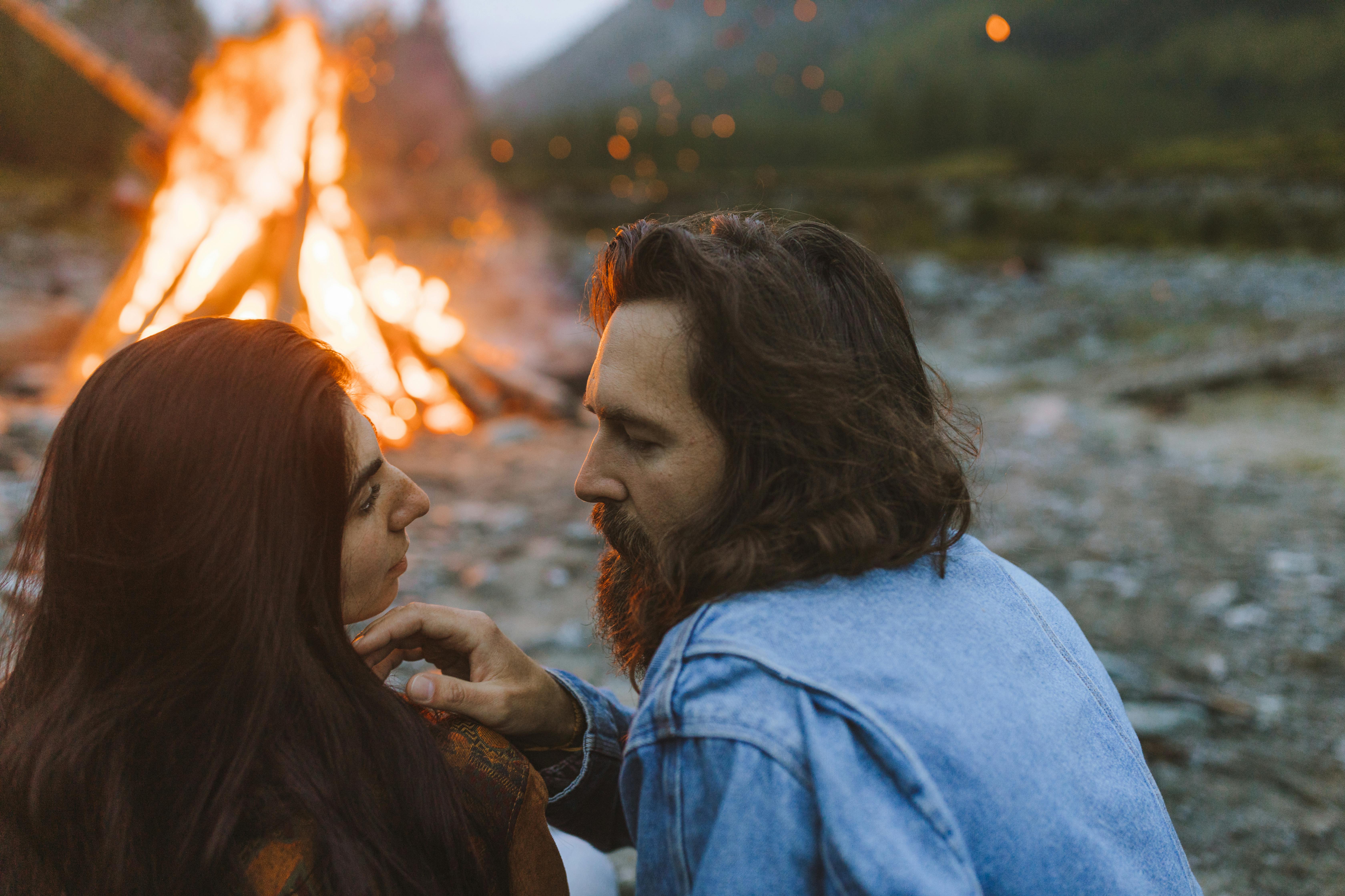Man and Woman Sitting Beside a Bonfire · Free Stock Photo
