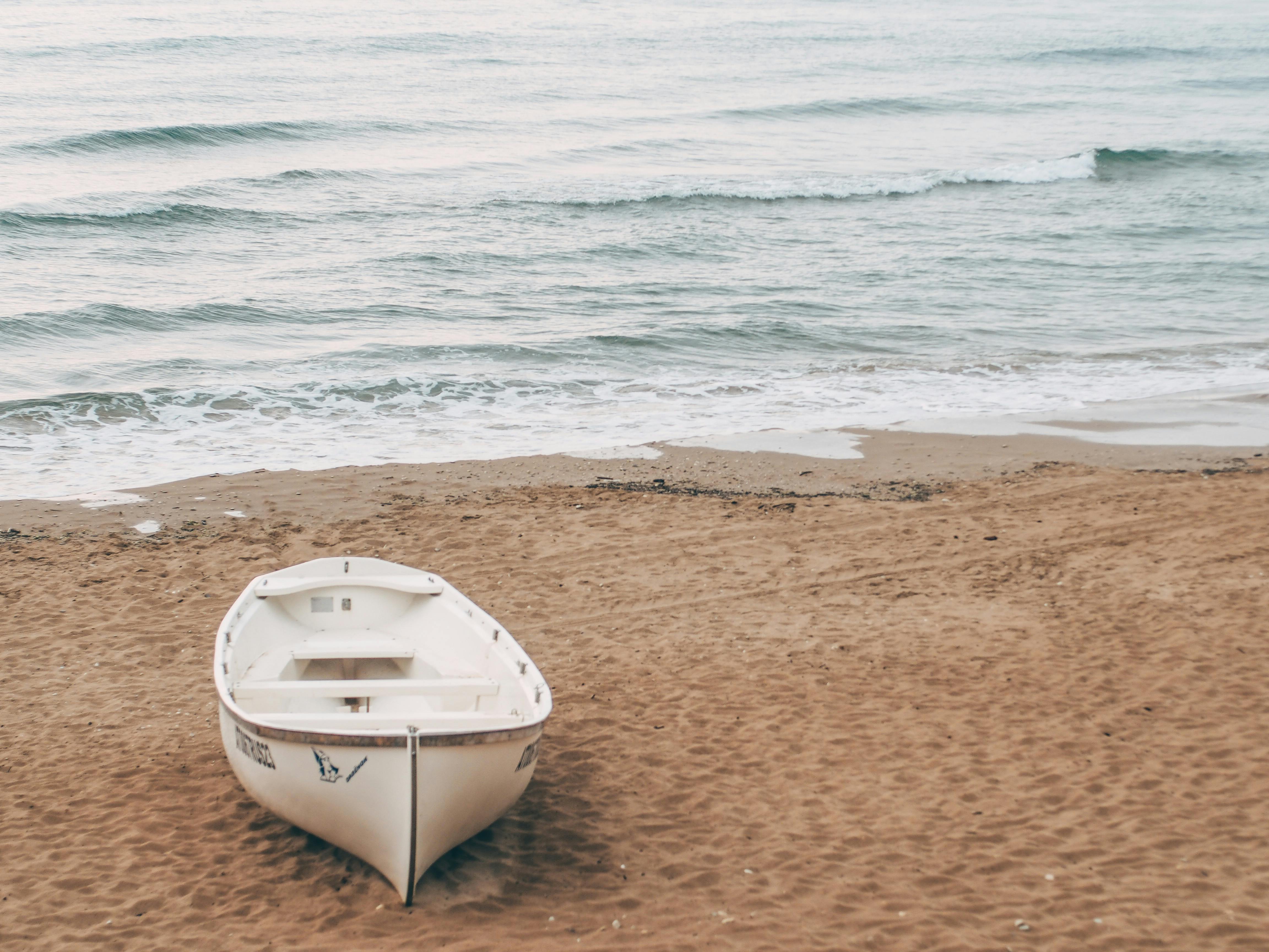 Boats on a Beach Near a Cliff · Free Stock Photo