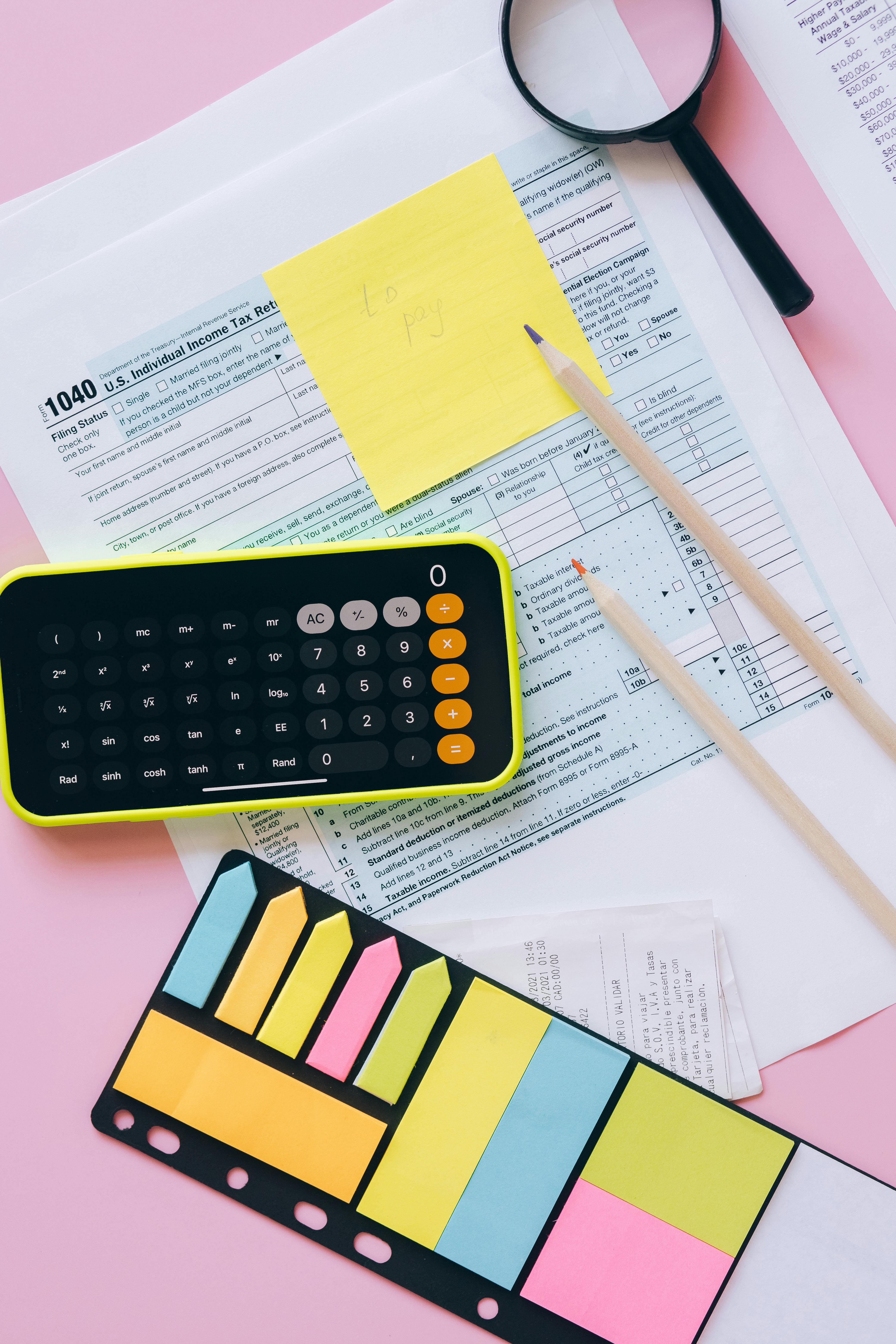 Calculator and Sticky Notes on Papers · Free Stock Photo