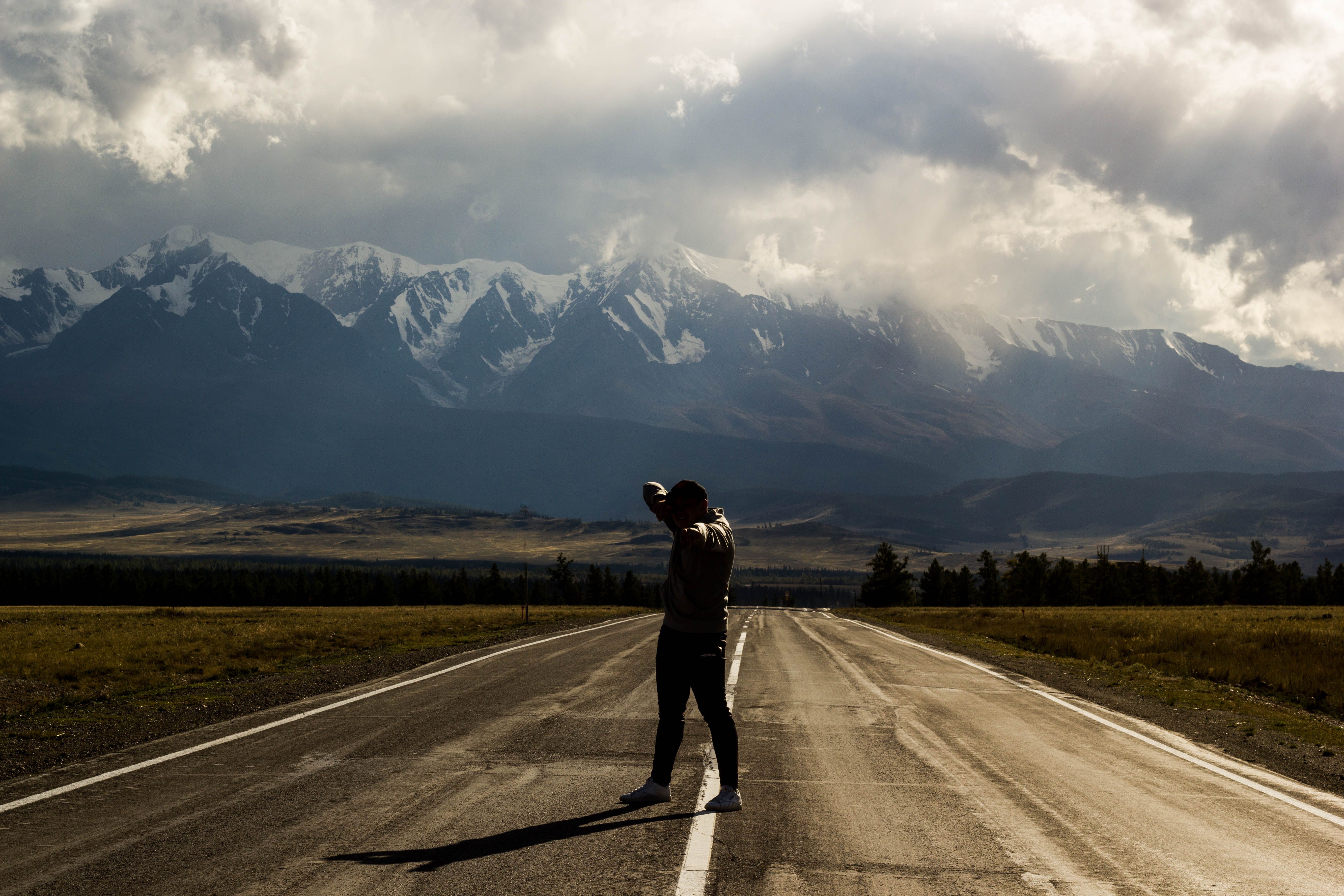 Man Standing on Empty Road · Free Stock Photo