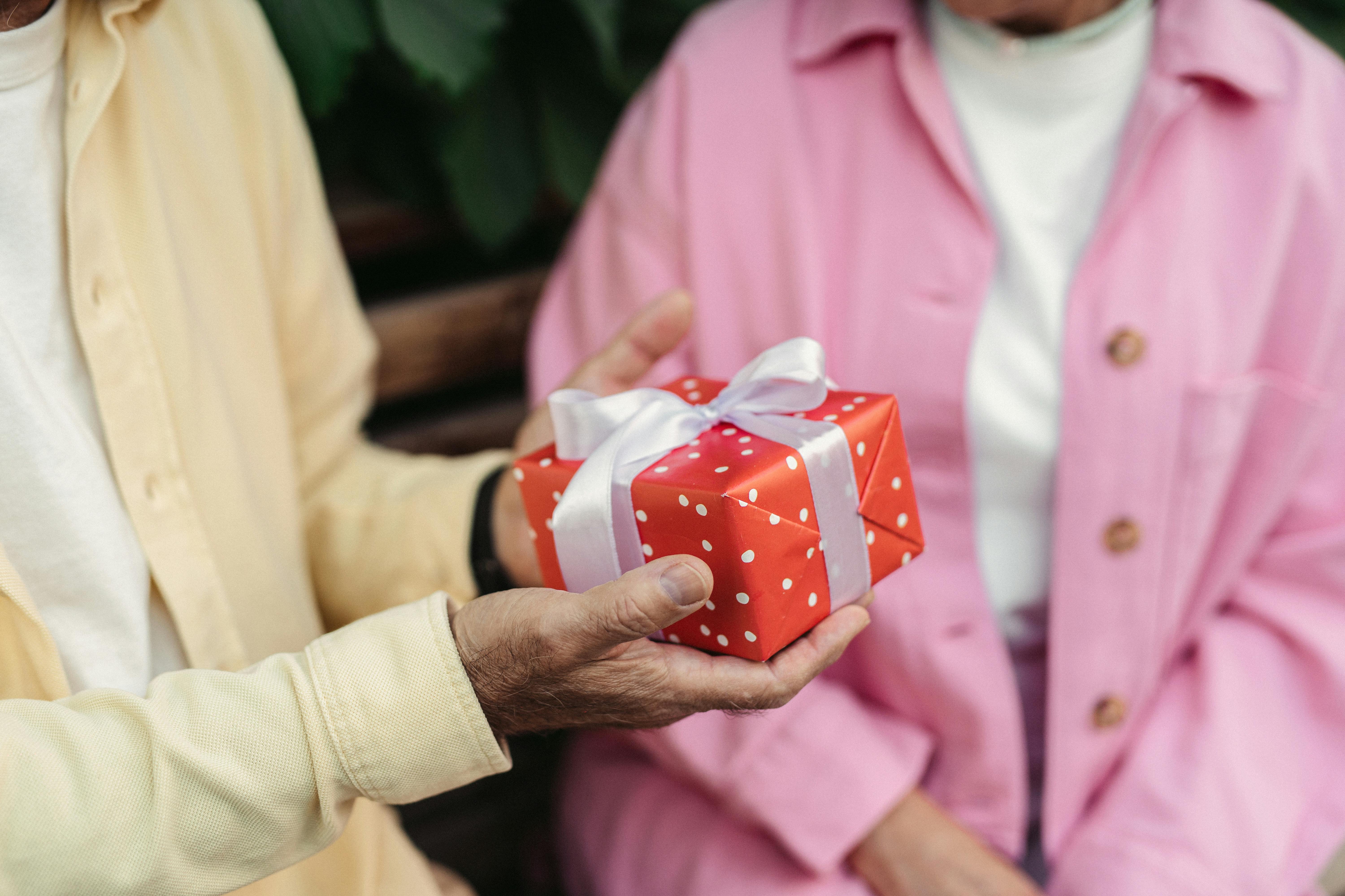 A Person Holding a Present · Free Stock Photo