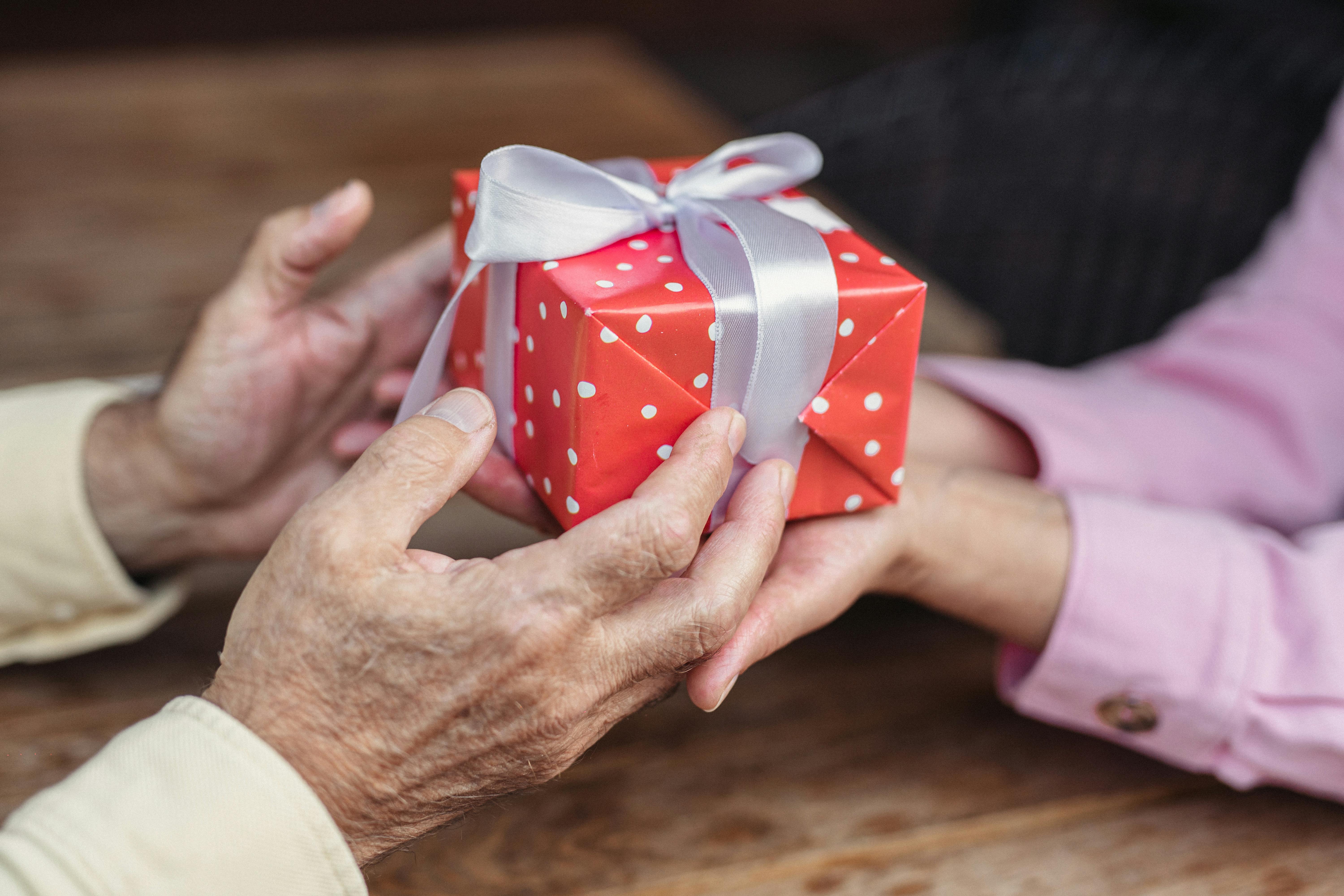 Elderly Woman Opening a Gift · Free Stock Photo