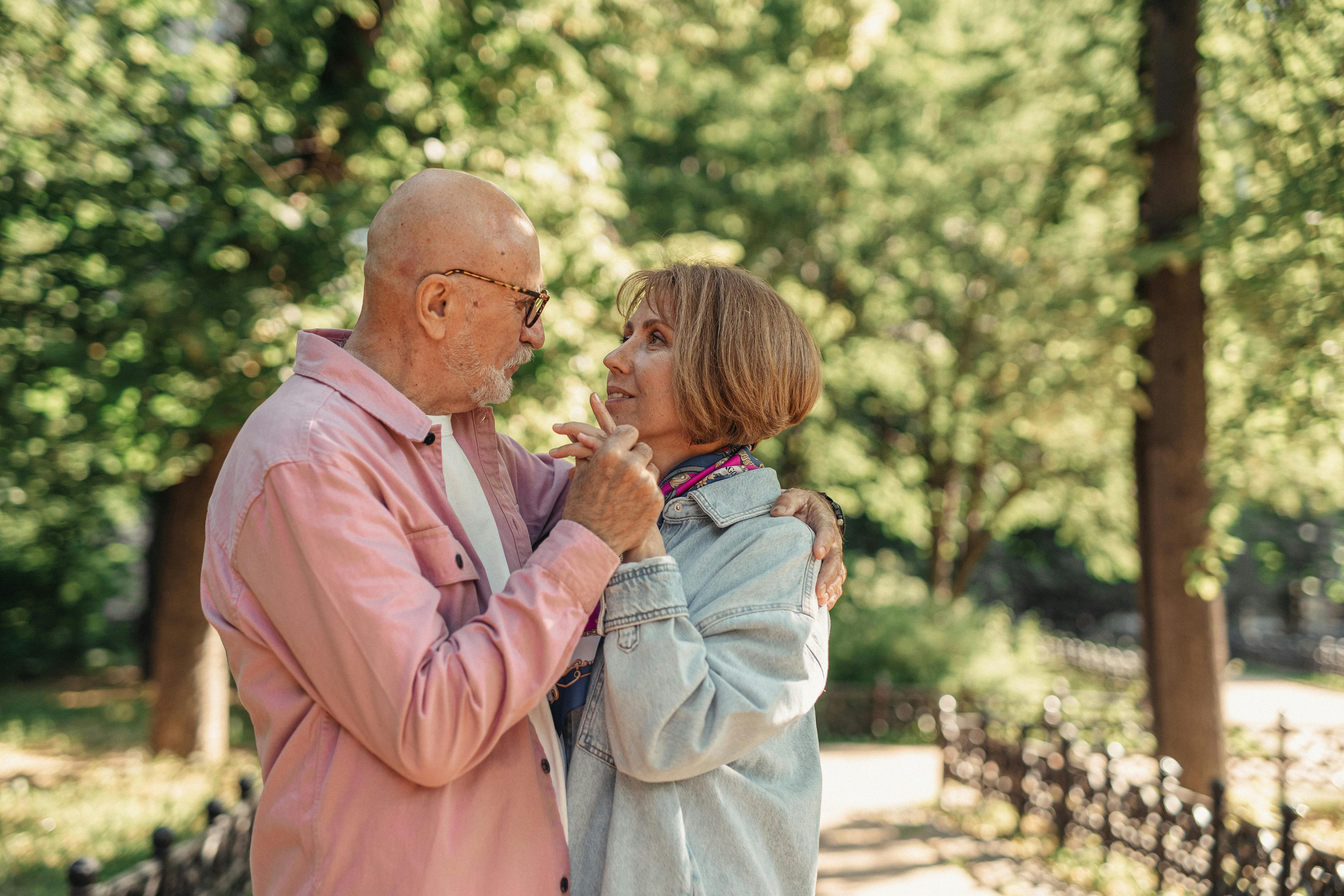 Man in Pink Jacket Hugging Woman in Blue Denim Jacket · Free Stock Photo