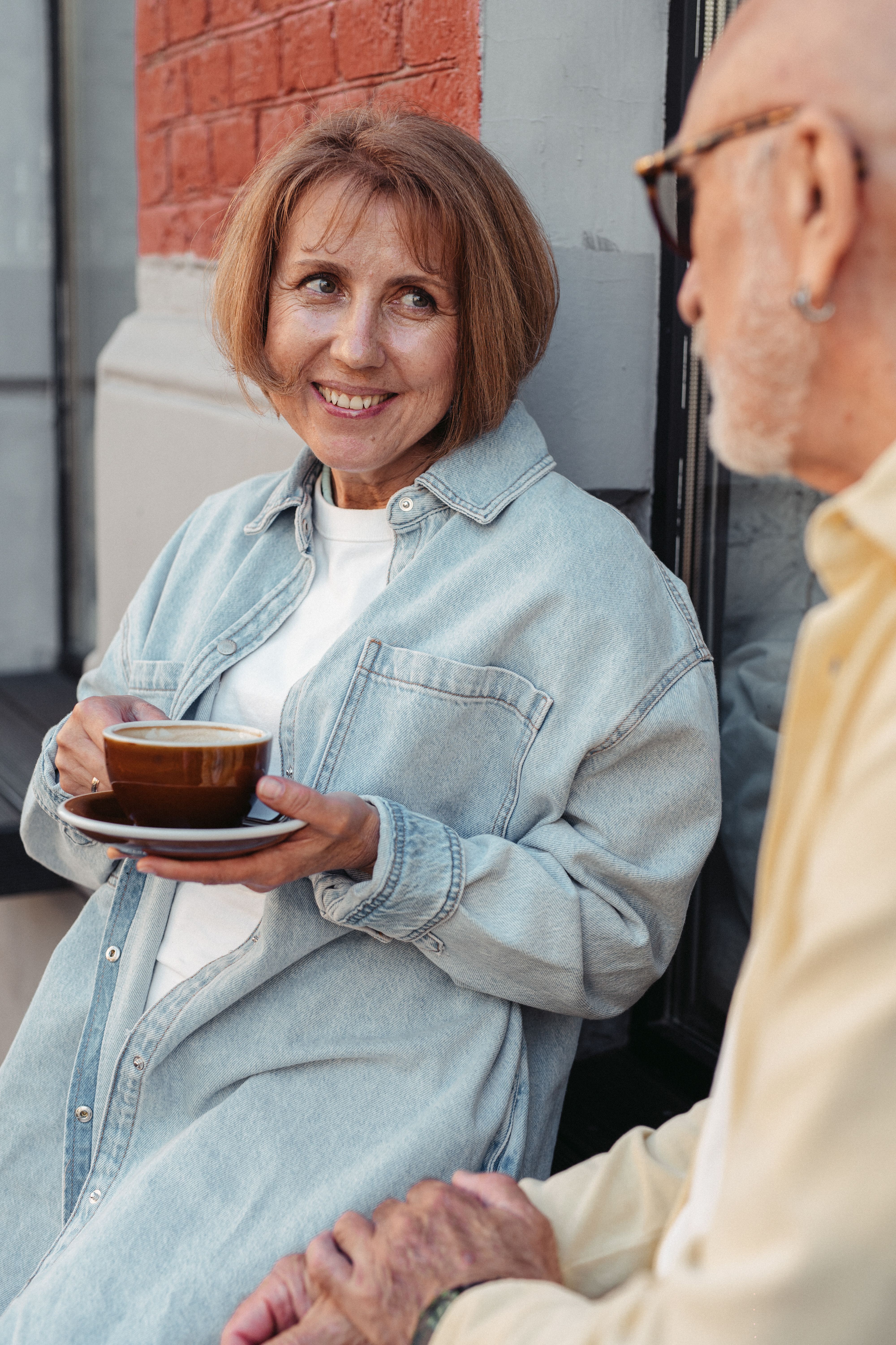 Woman in Blue Denim Jacket Holding Brown Ceramic Mug · Free Stock Photo