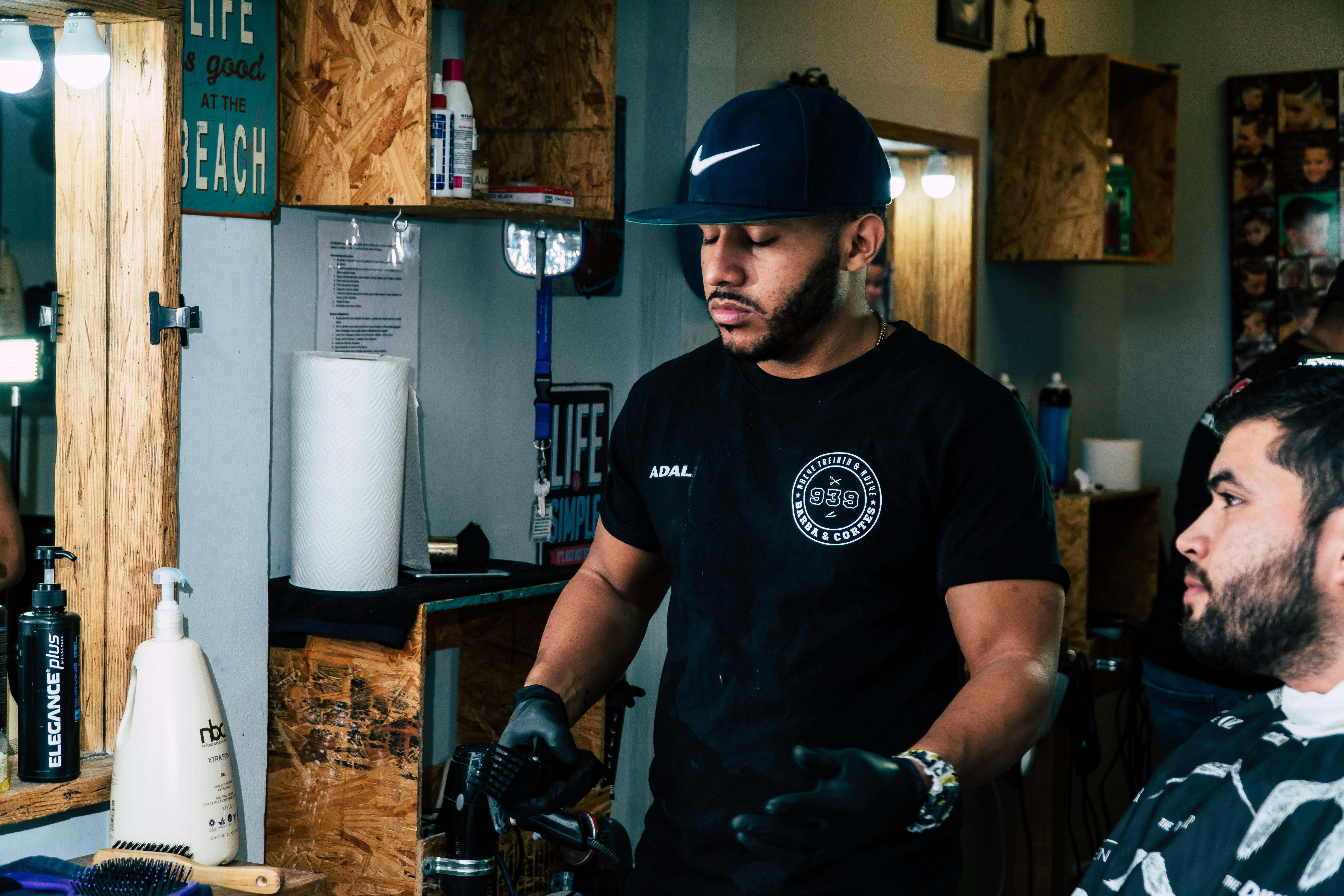 Man Wearing Black Shirt Trimming the Hair of Man · Free Stock Photo