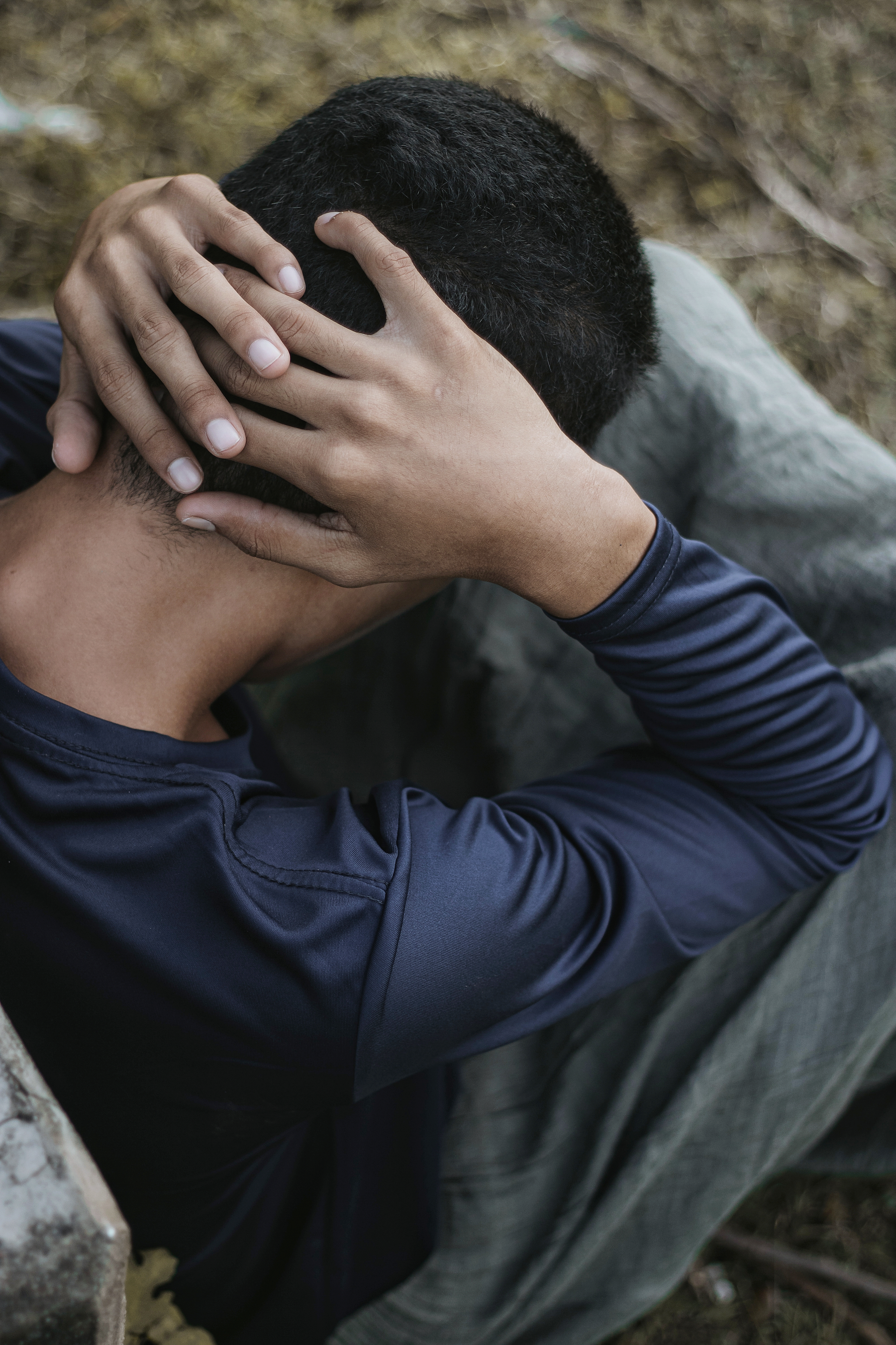 Man Sitting with his Hands on the Neck · Free Stock Photo
