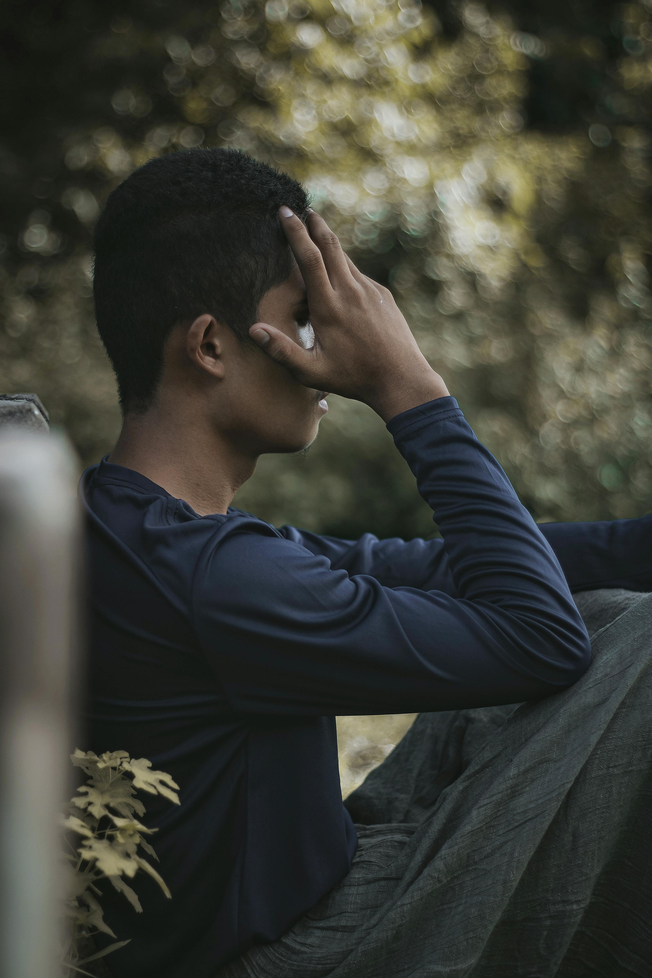 Man Sitting with His Hand Touching His Head · Free Stock Photo
