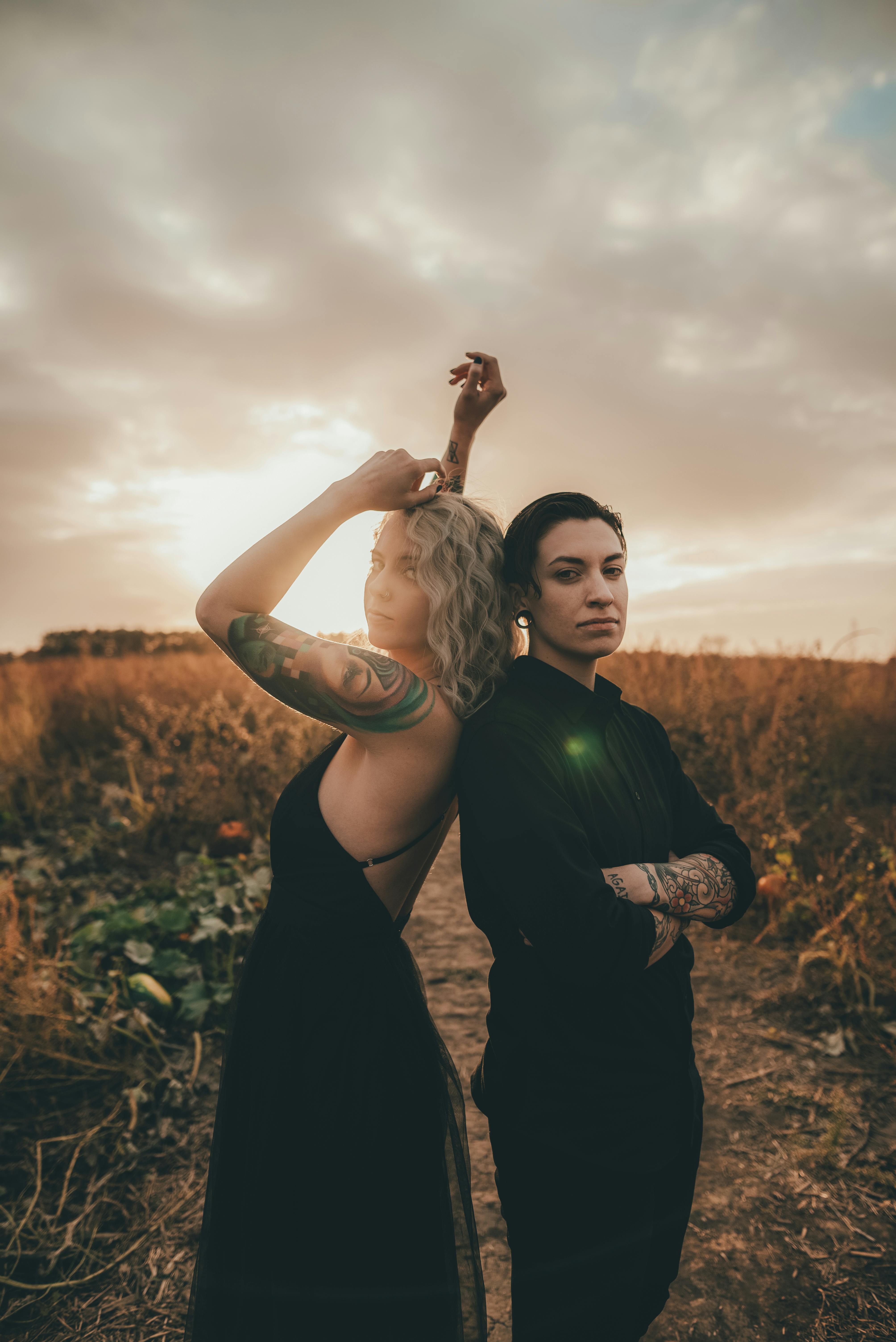 A Two Women Posing Back To Back · Free Stock Photo