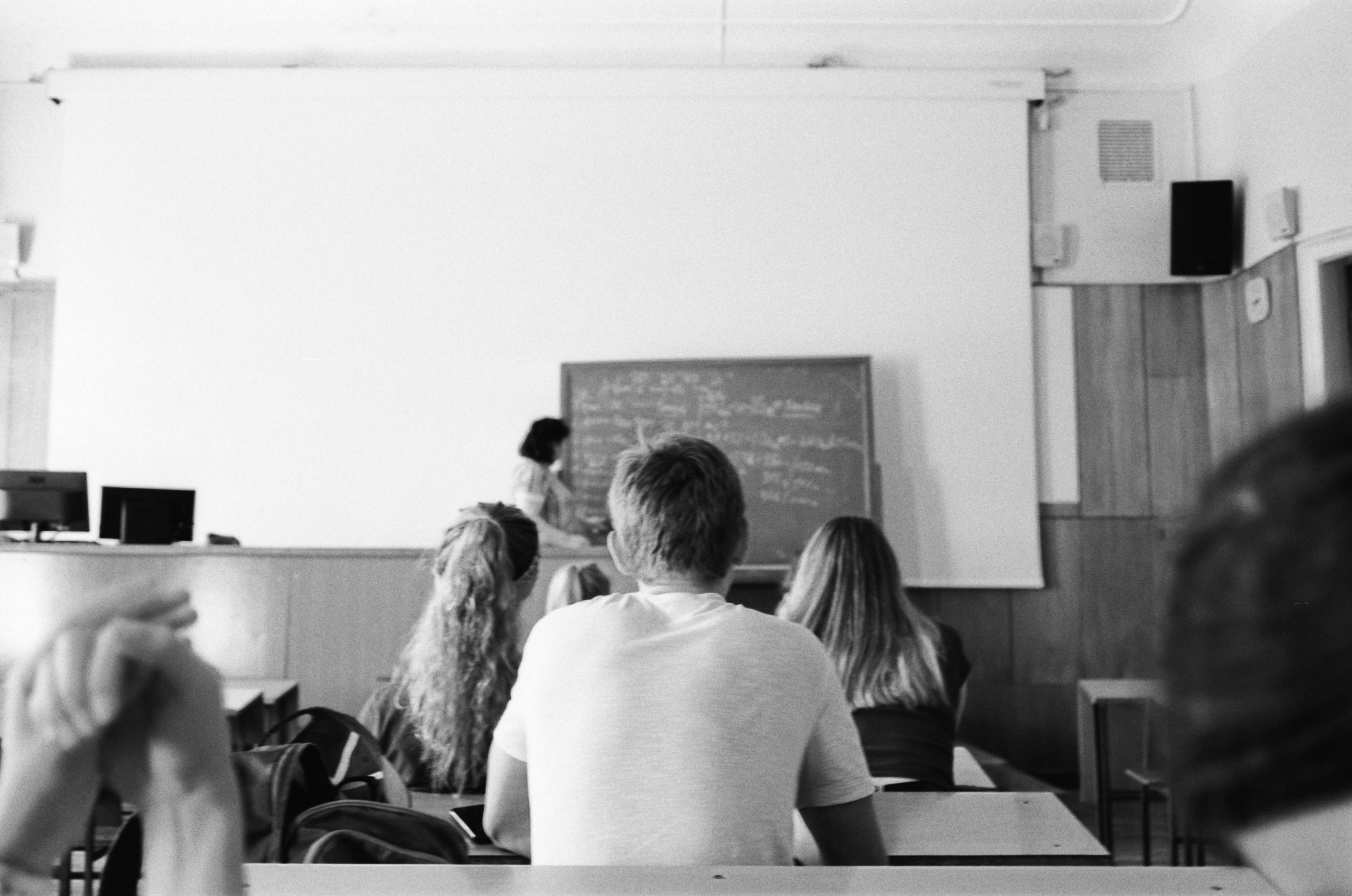 Grayscale Photo of a Classroom · Free Stock Photo