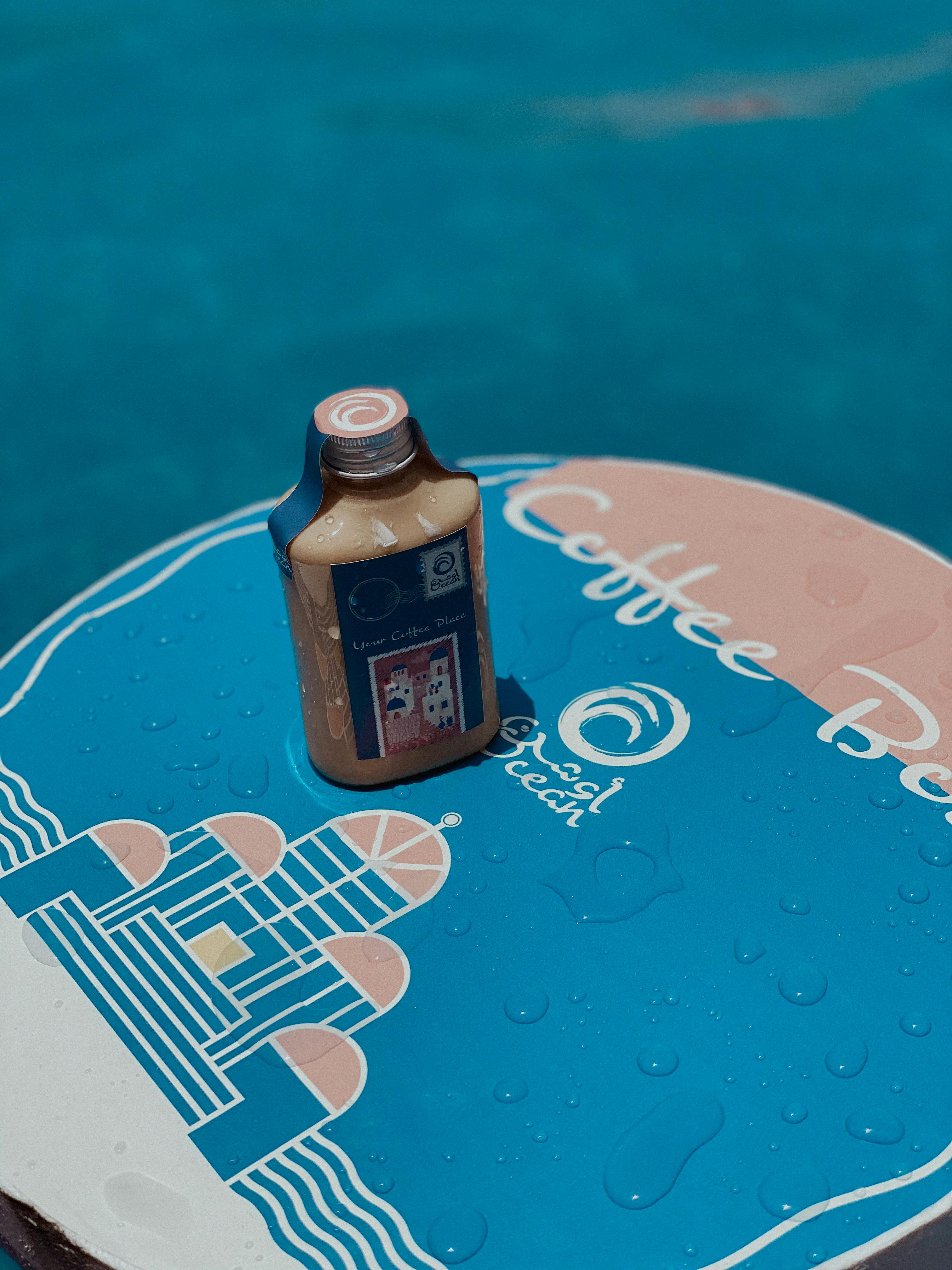 A Close-Up Shot of a Bottled Coffee on a Floater · Free Stock Photo