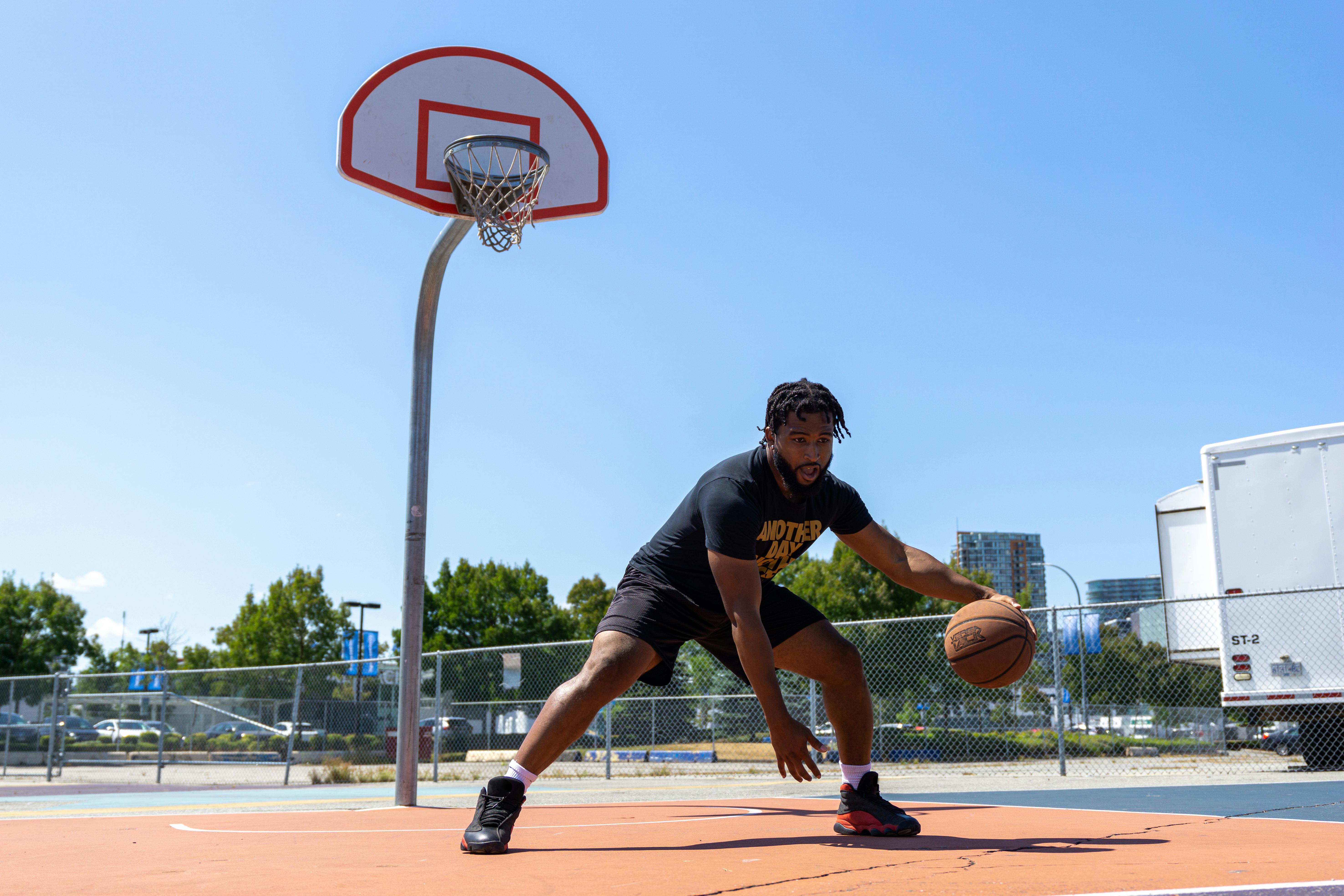 Concentrated men playing basketball on court · Free Stock Photo