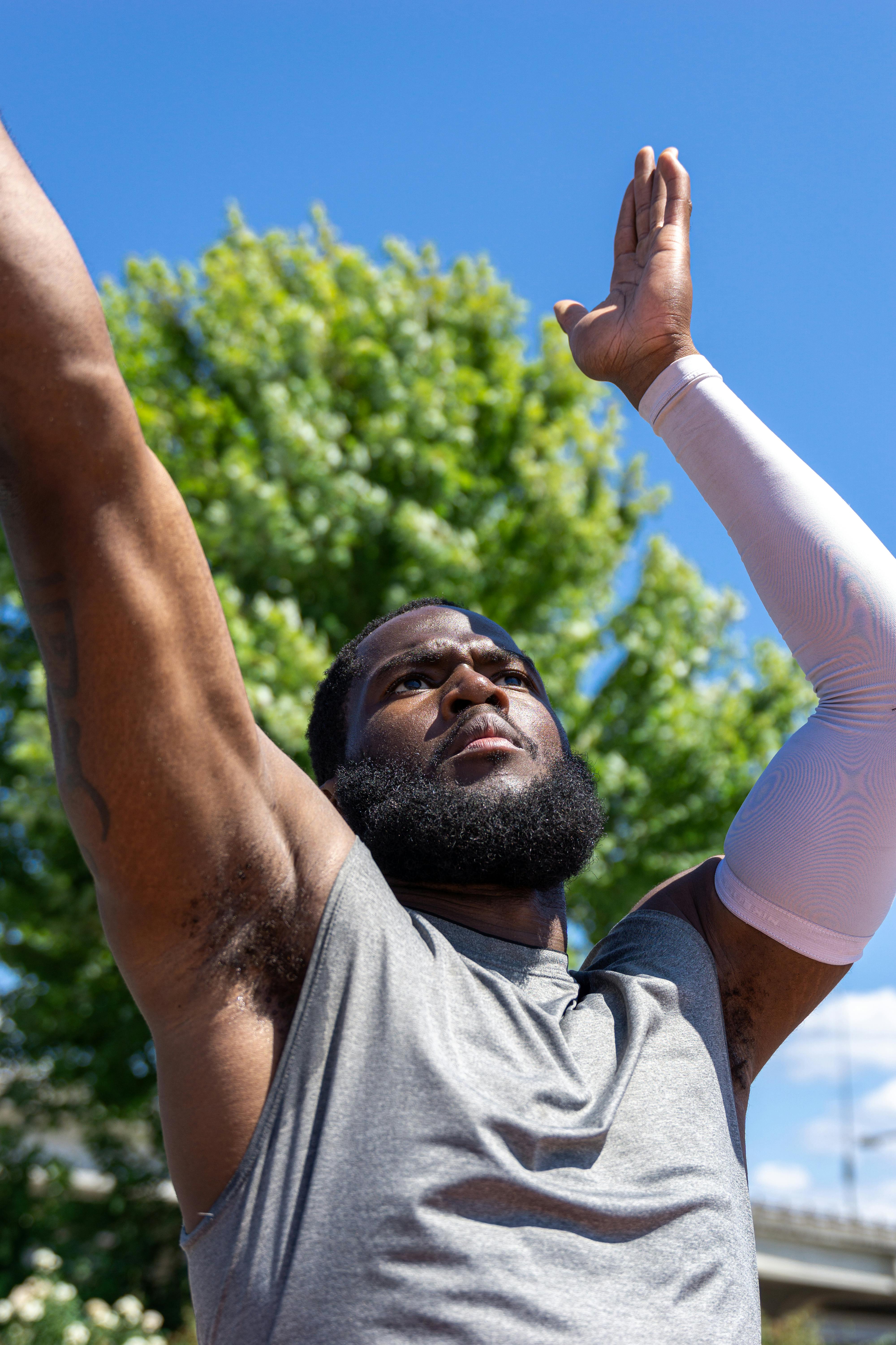 Man Hands Raised Up High While Playing · Free Stock Photo