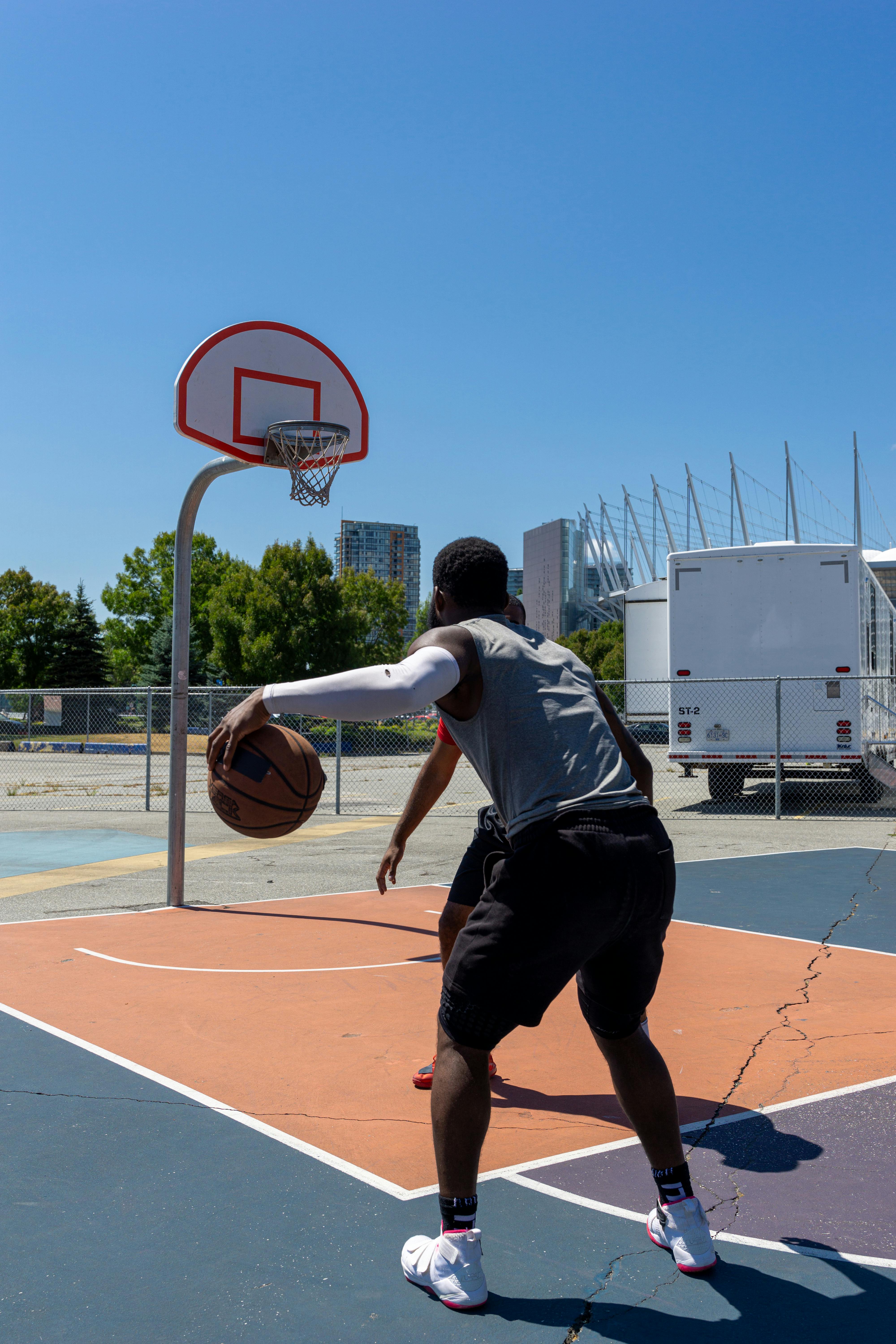 A Man Running While Holding a Basketball · Free Stock Photo
