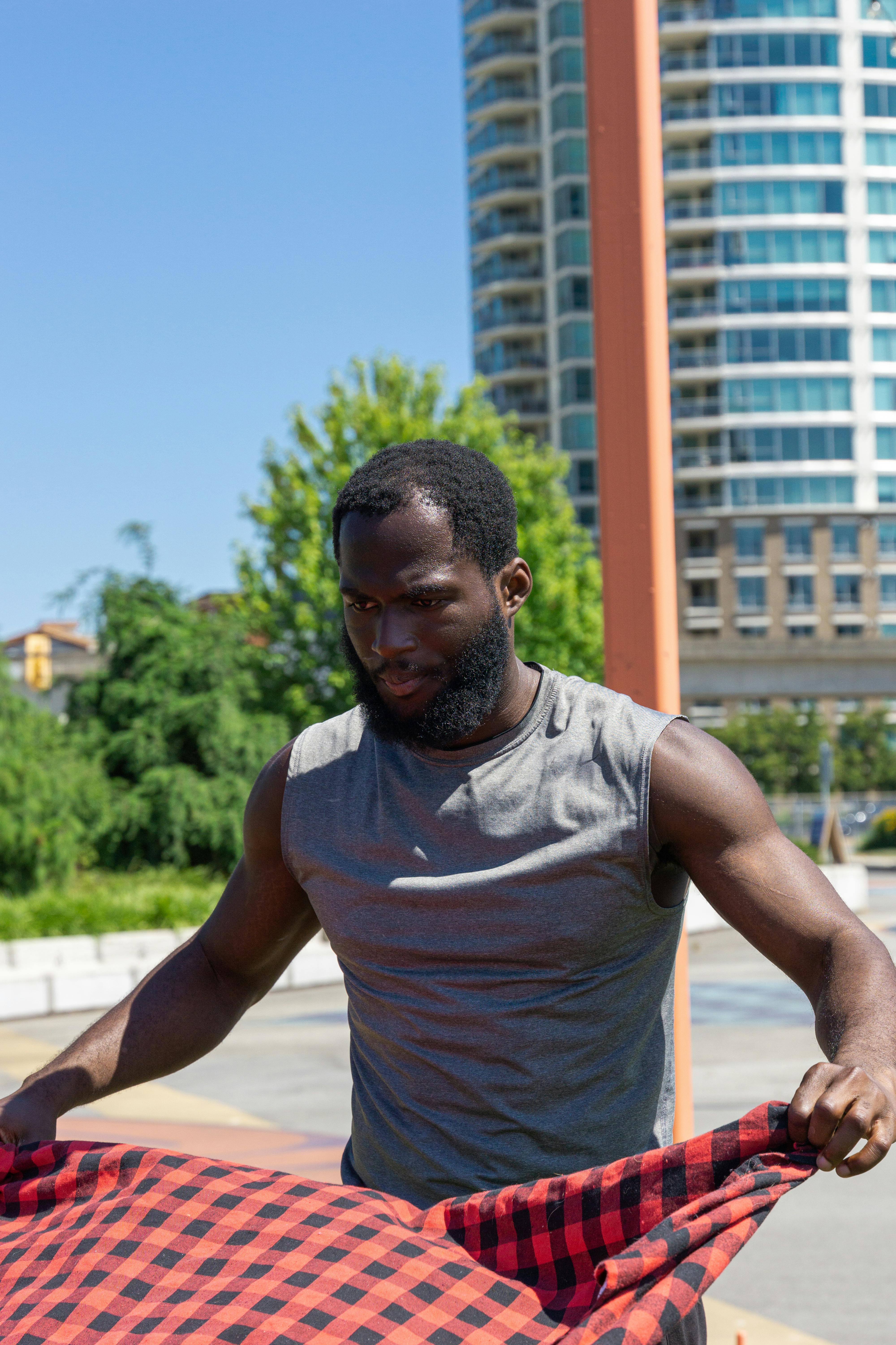 A Man Shaking Off the Picnic Blanket · Free Stock Photo