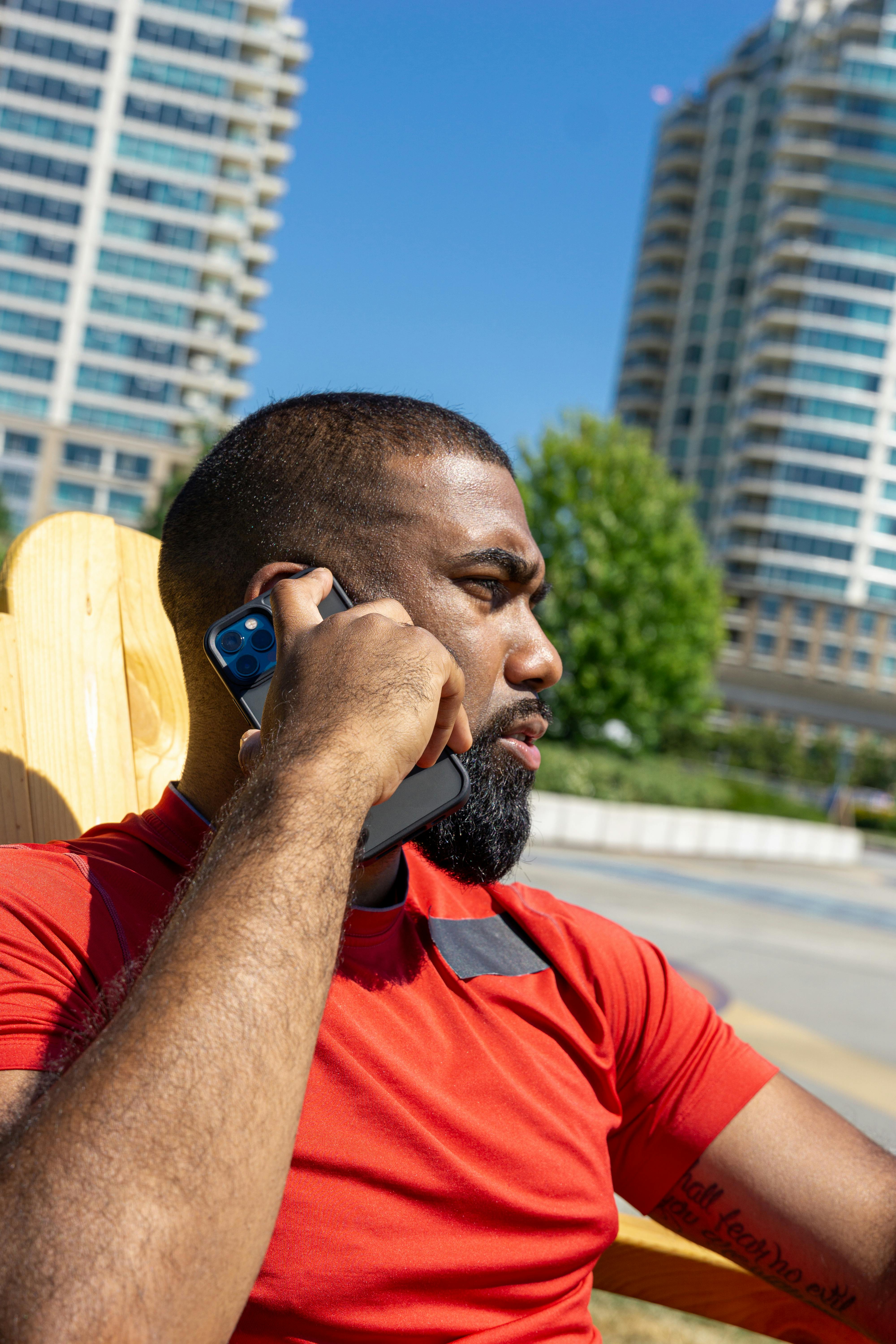 Man in Red T-Shirt Talking on the Phone · Free Stock Photo