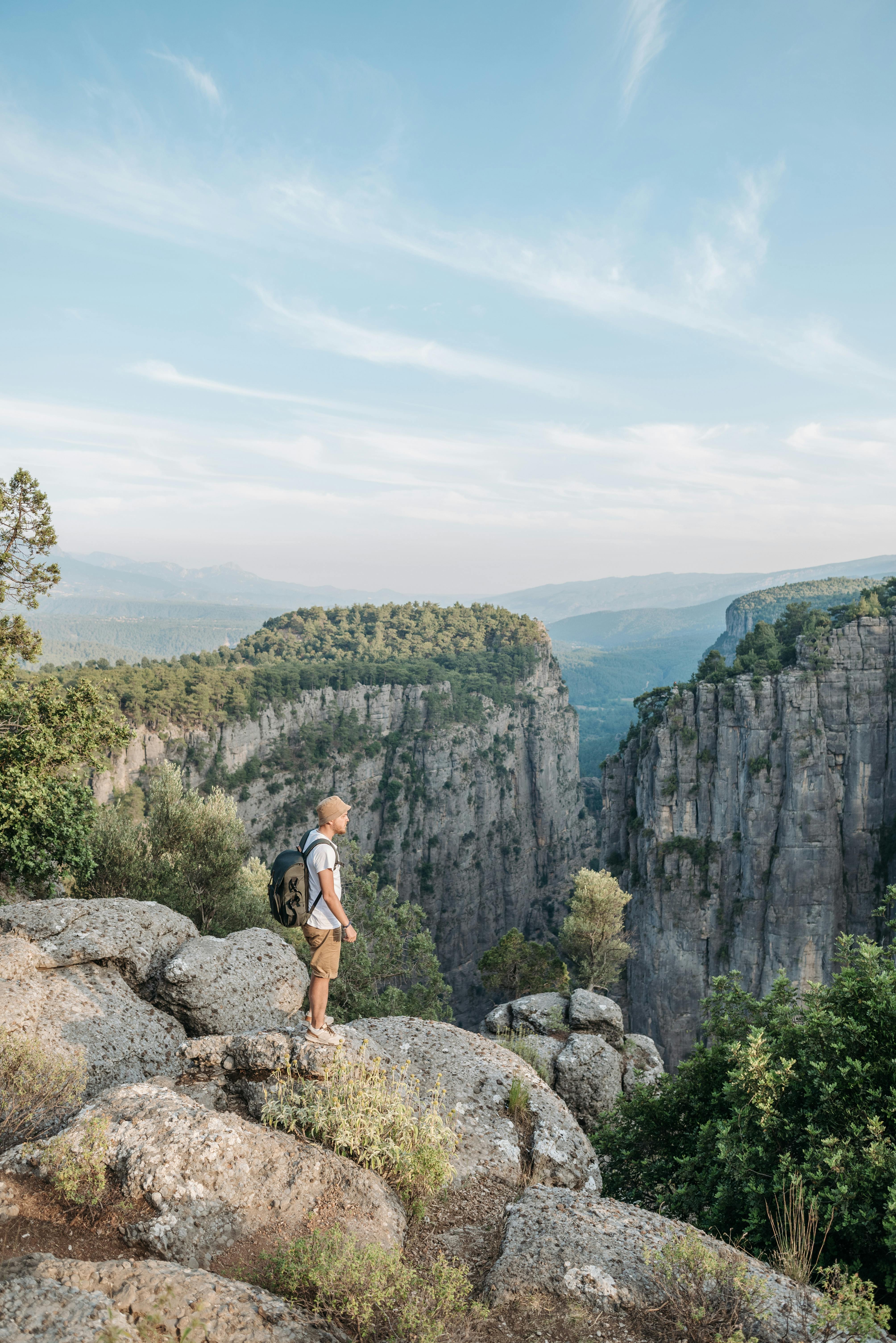 Person Standing on Rock · Free Stock Photo