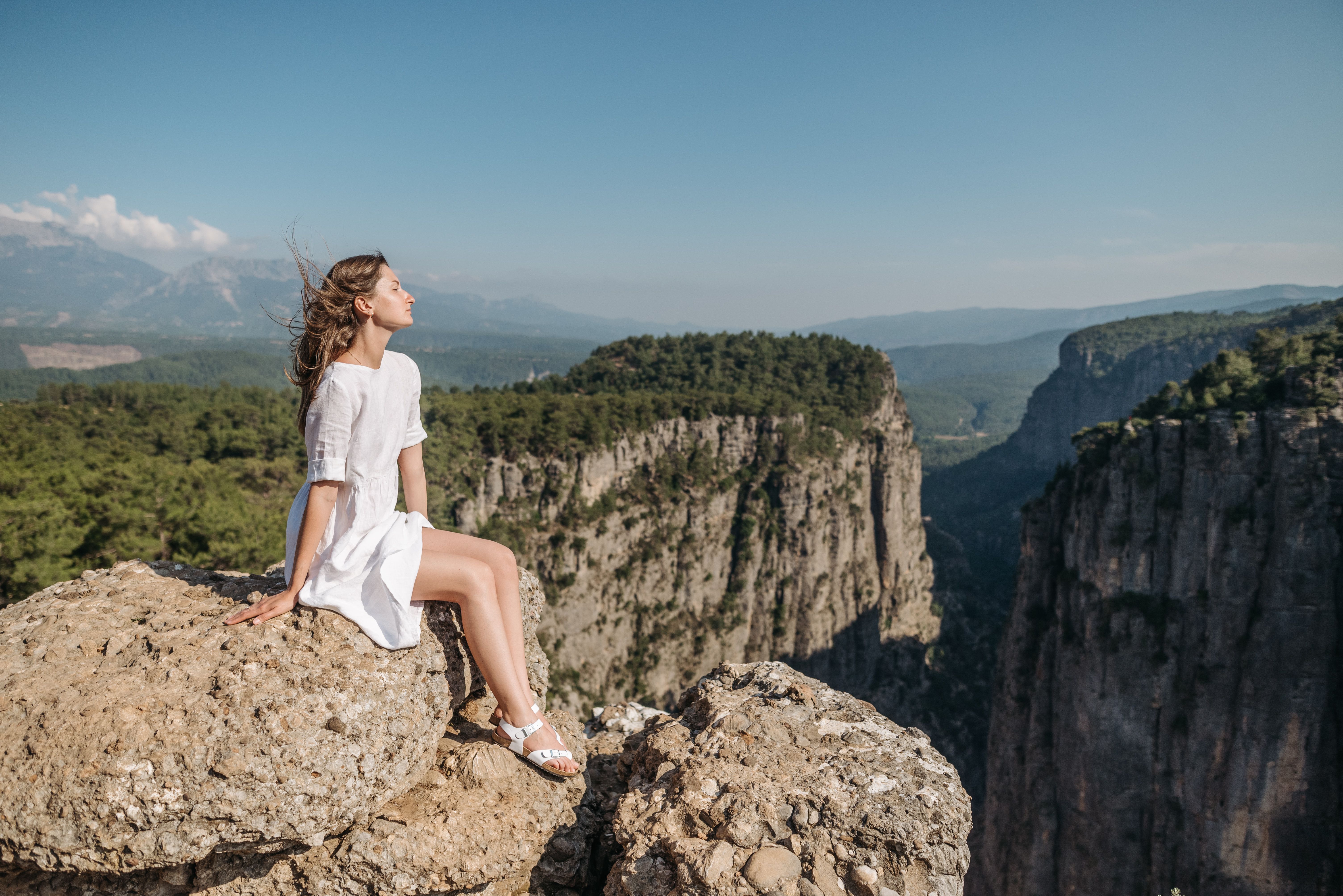 A Woman Sitting on a Cliff · Free Stock Photo