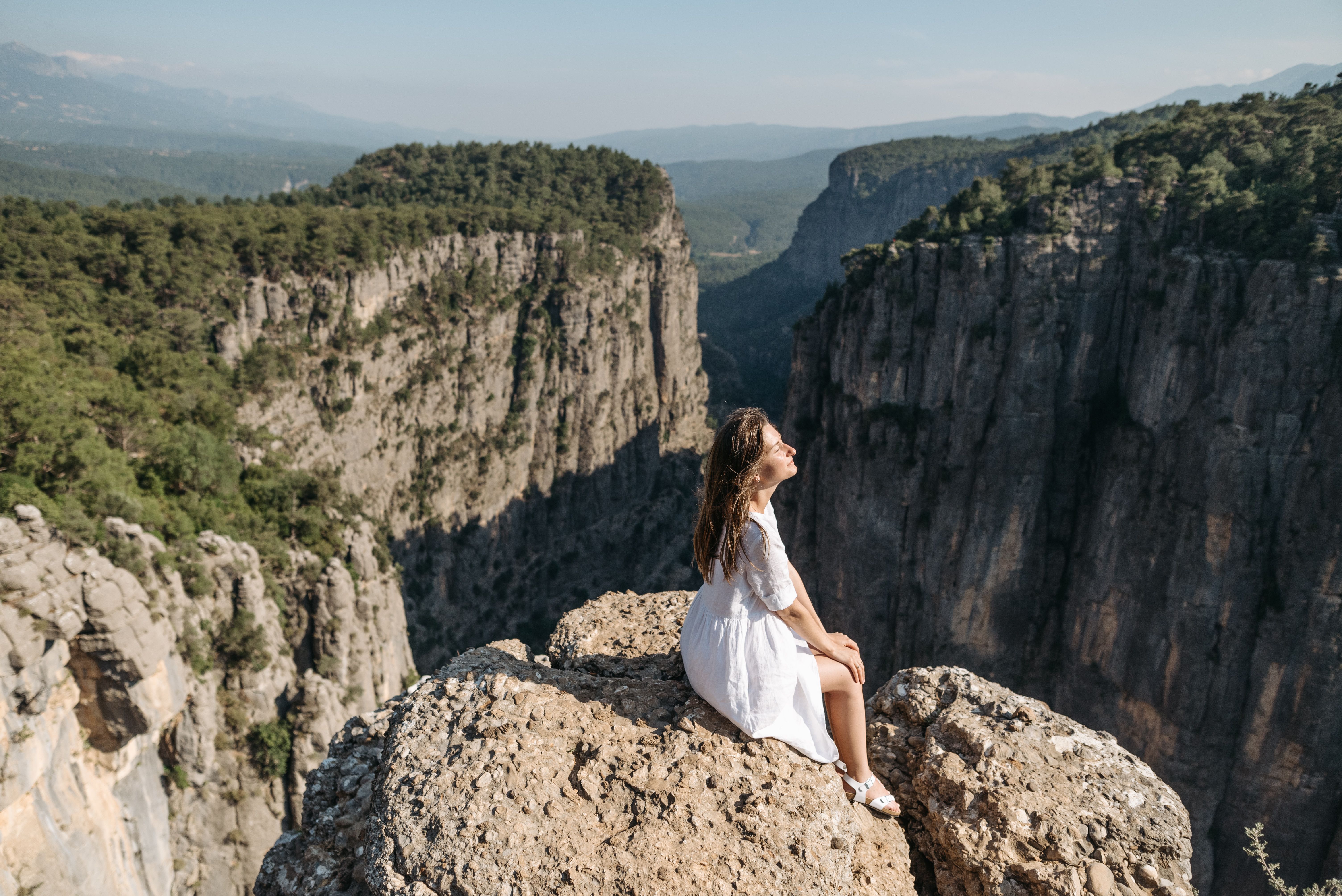 Woman in White Dress Sitting on a Cliff · Free Stock Photo