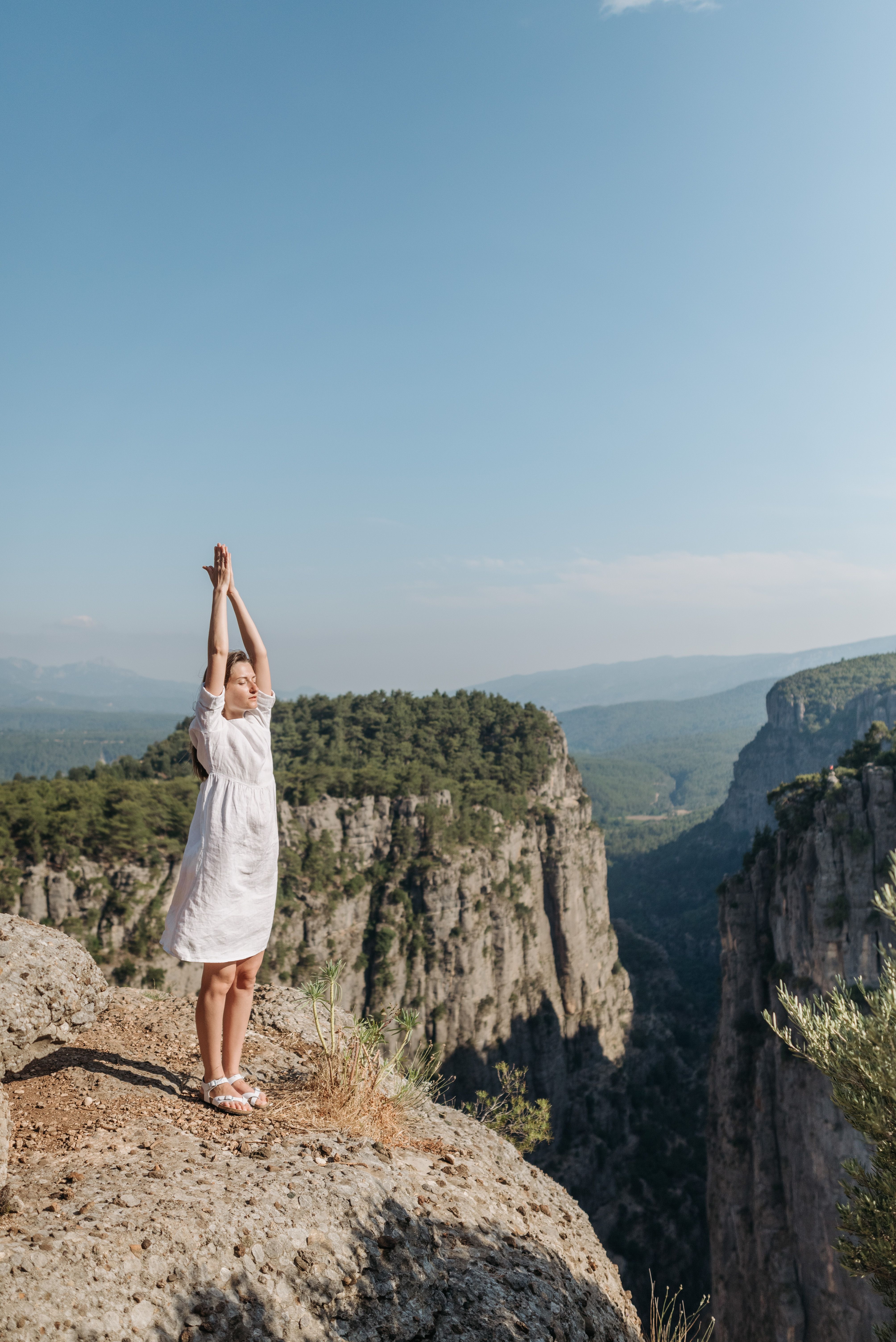 Woman in White Dress Standing on a Rock Cliff · Free Stock Photo