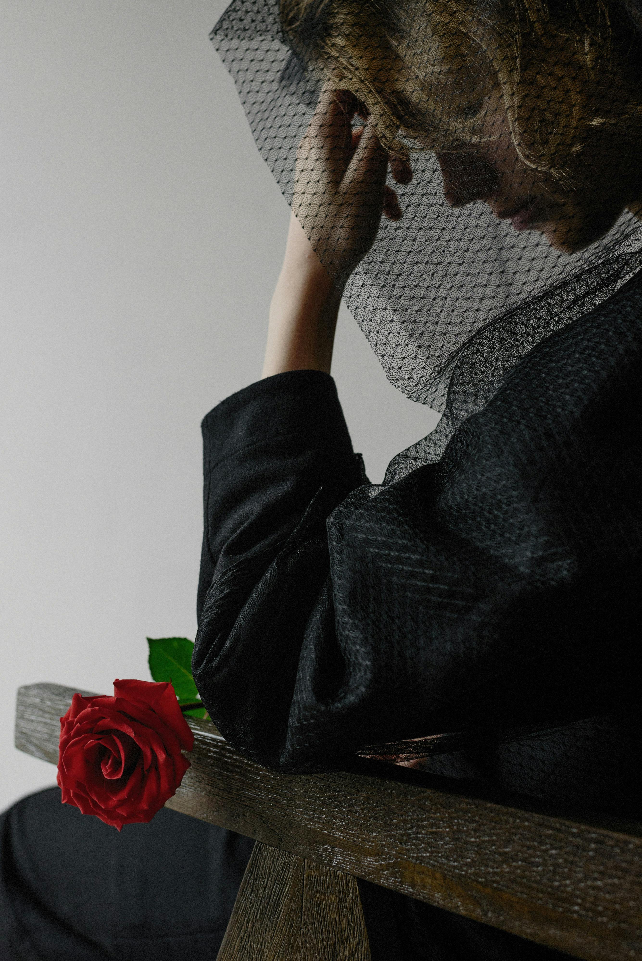 Profile of a Grieving Widow, Wearing a Black Veil, and Holding a Red ...