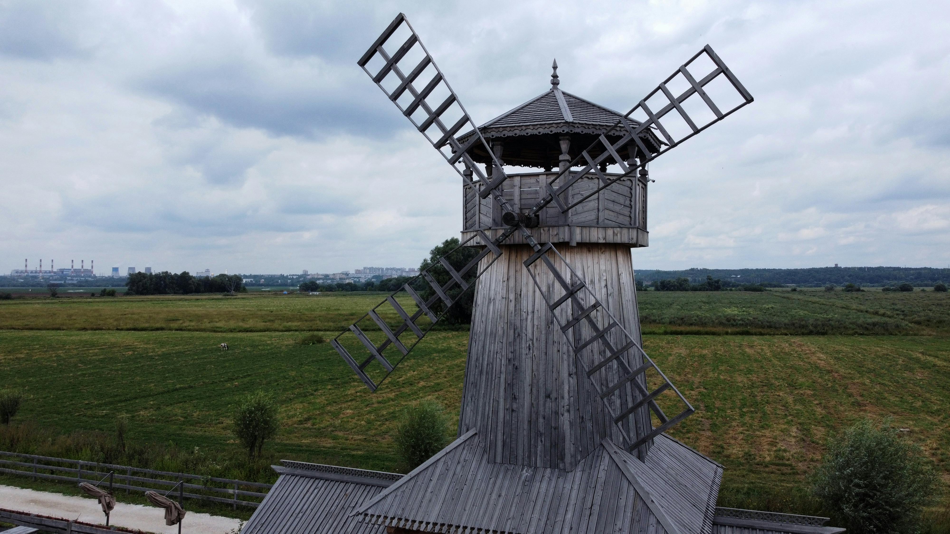 Brown and Gray Windmill Beside Green Tree Under Blue Cloudy Sky during ...