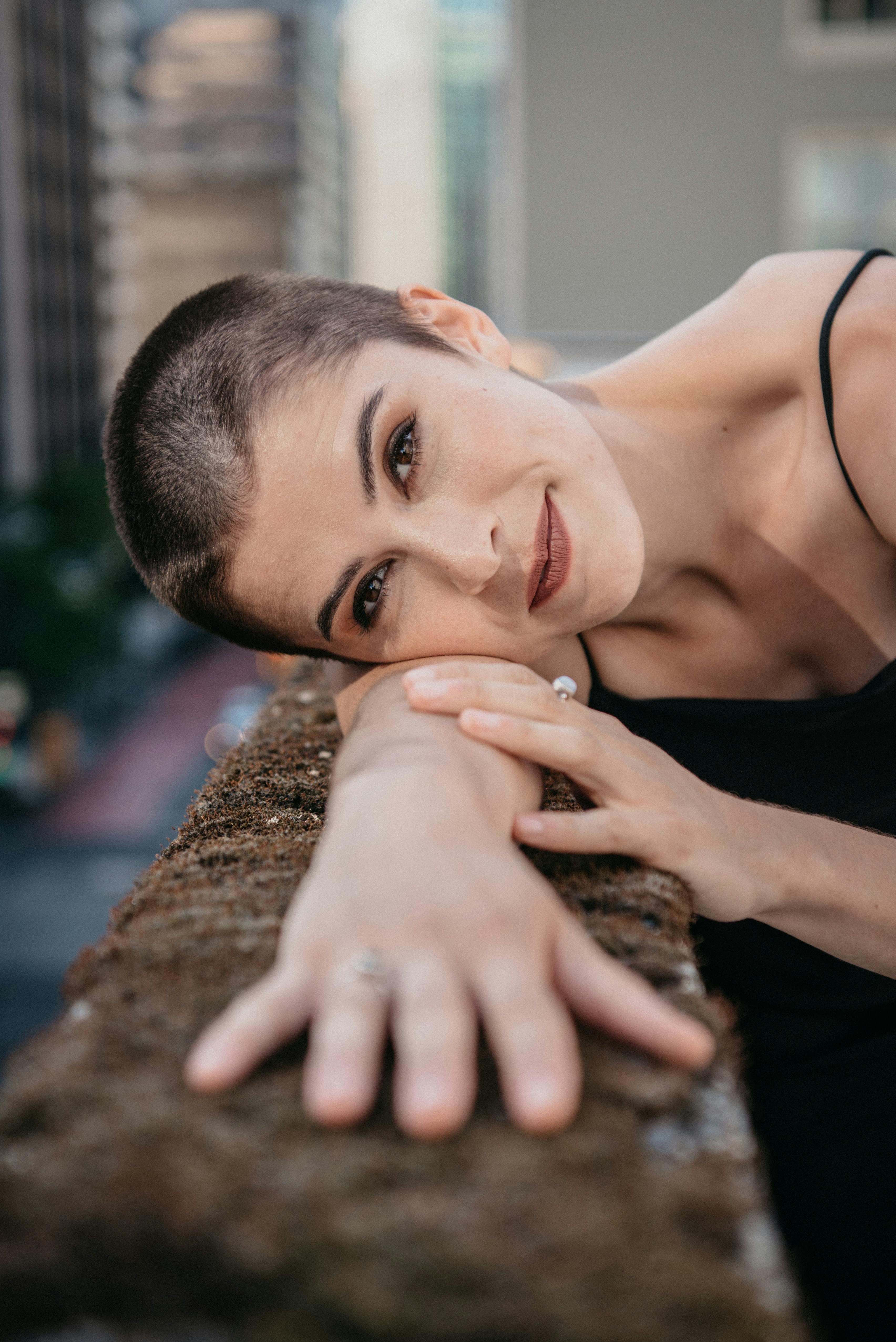 Woman in Black Spaghetti Strap Top Leaning on Concrete Ledge · Free ...