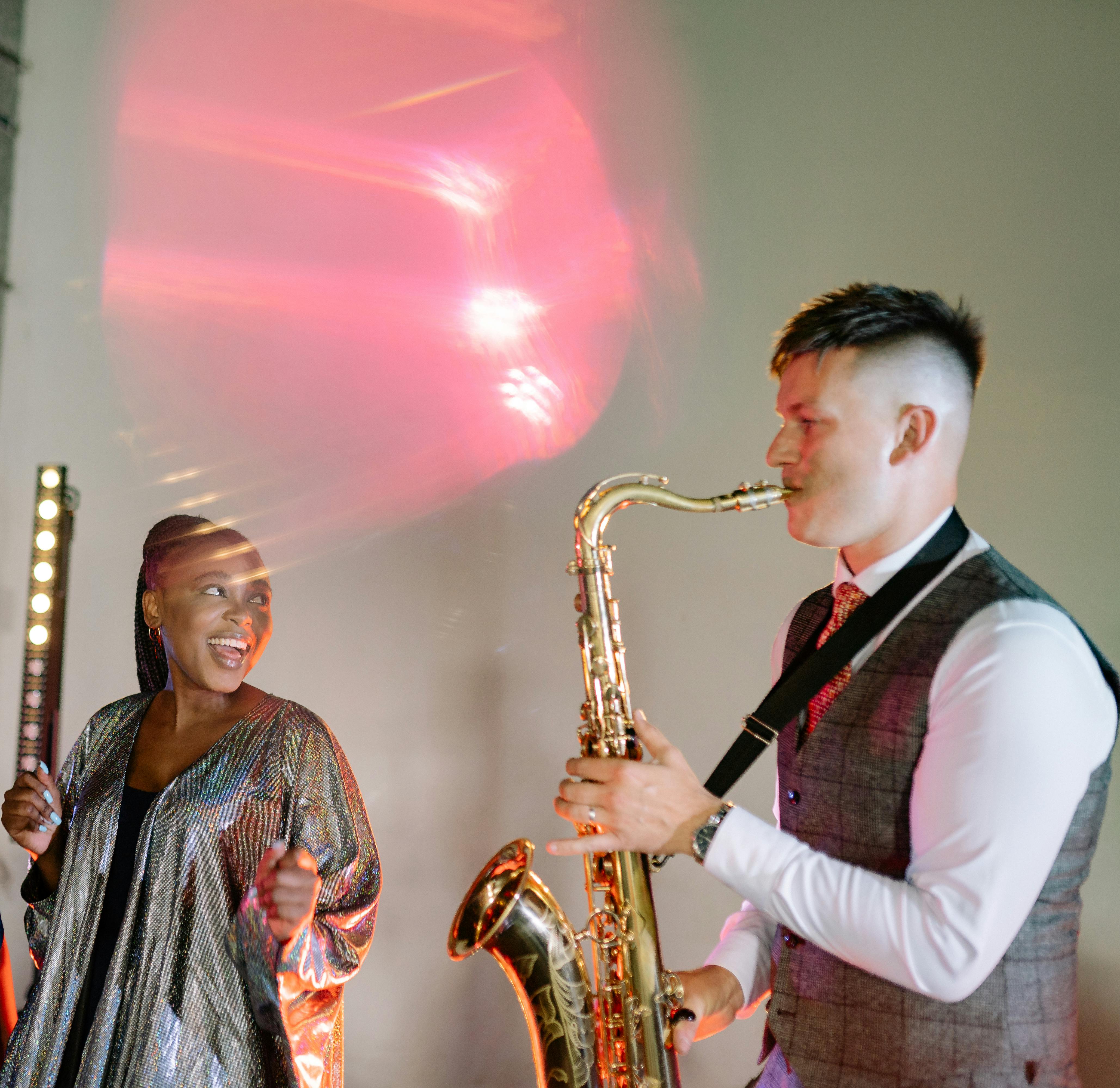 Brass Saxophone on Gray Table Near Black Bag · Free Stock Photo