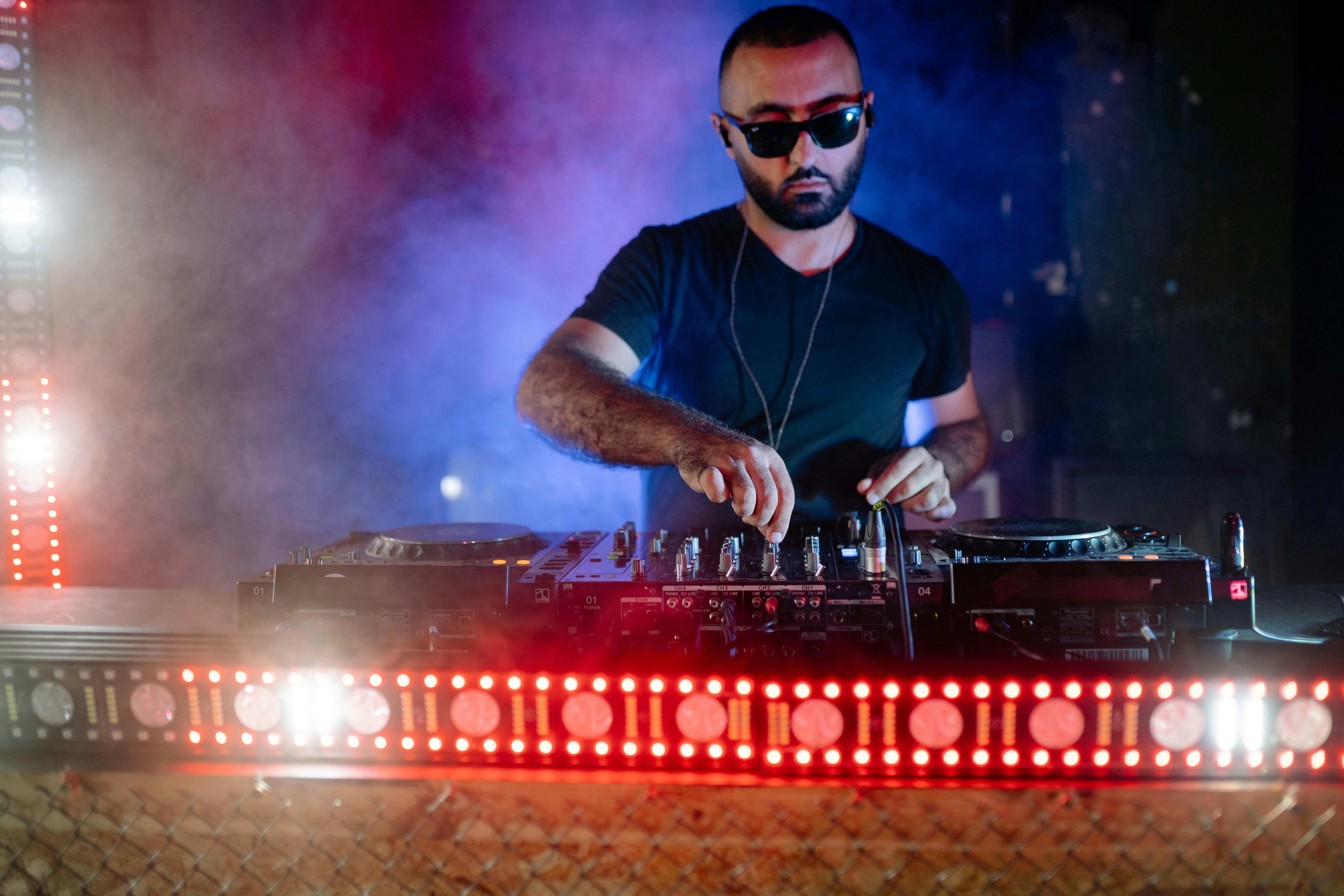 A Bearded Man Wearing Black Sunglasses Playing the Dj Mixer · Free ...