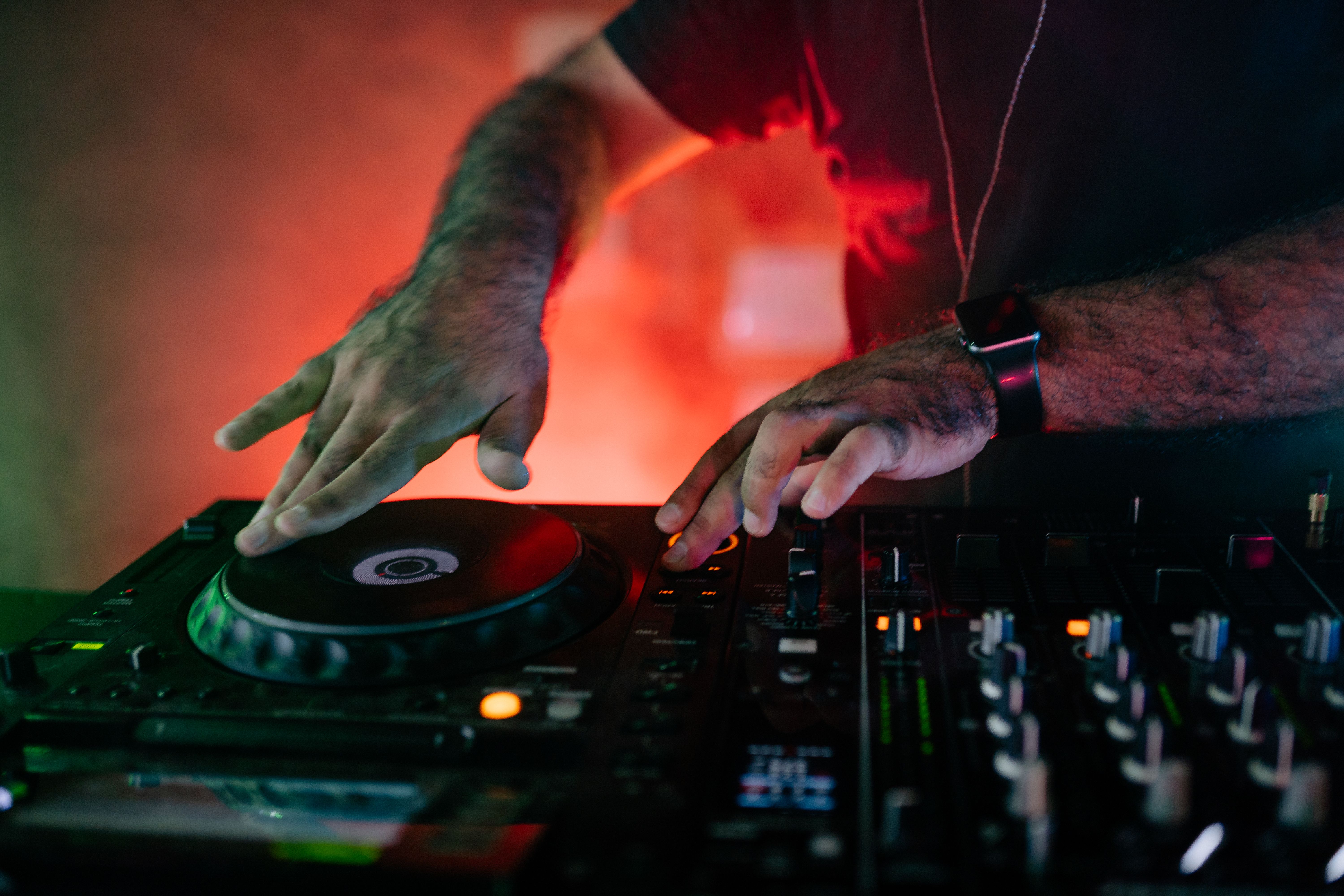Person Turning Knobs on DJ Digital Mixer Deck · Free Stock Photo