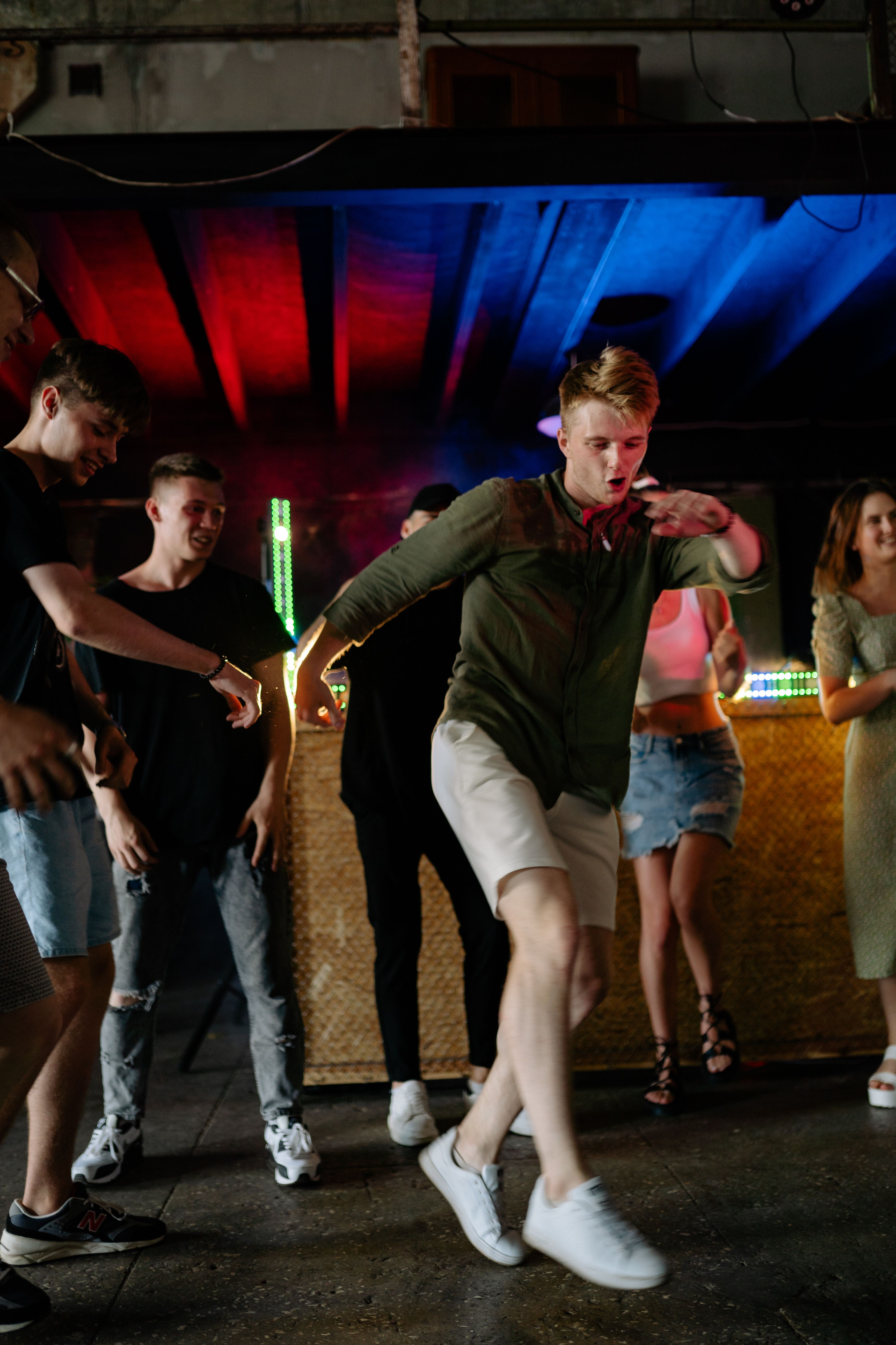 Man Wearing a Sweater Dancing Inside the Nightclub · Free Stock Photo