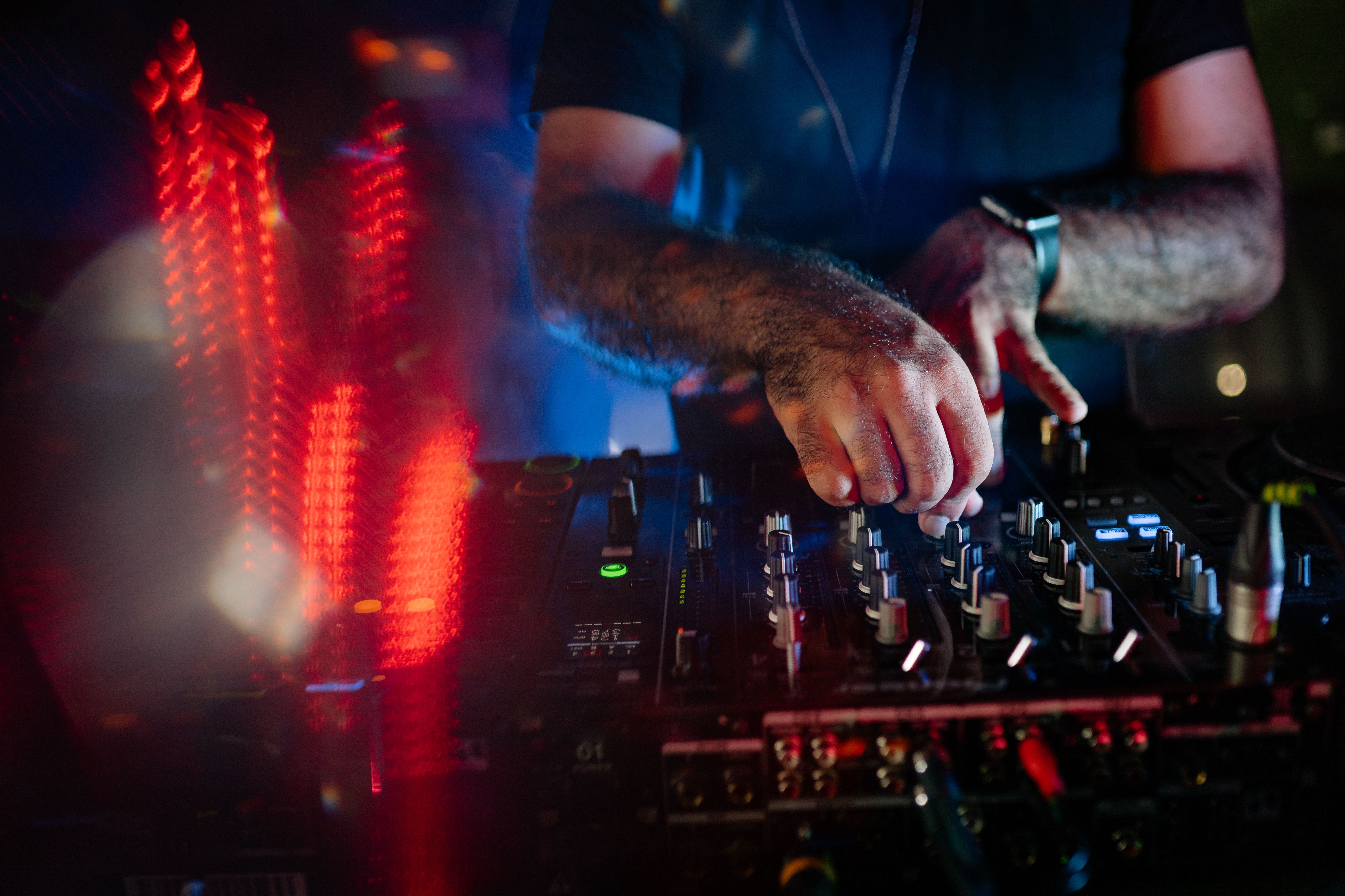 Person Turning Knobs on DJ Digital Mixer Deck · Free Stock Photo