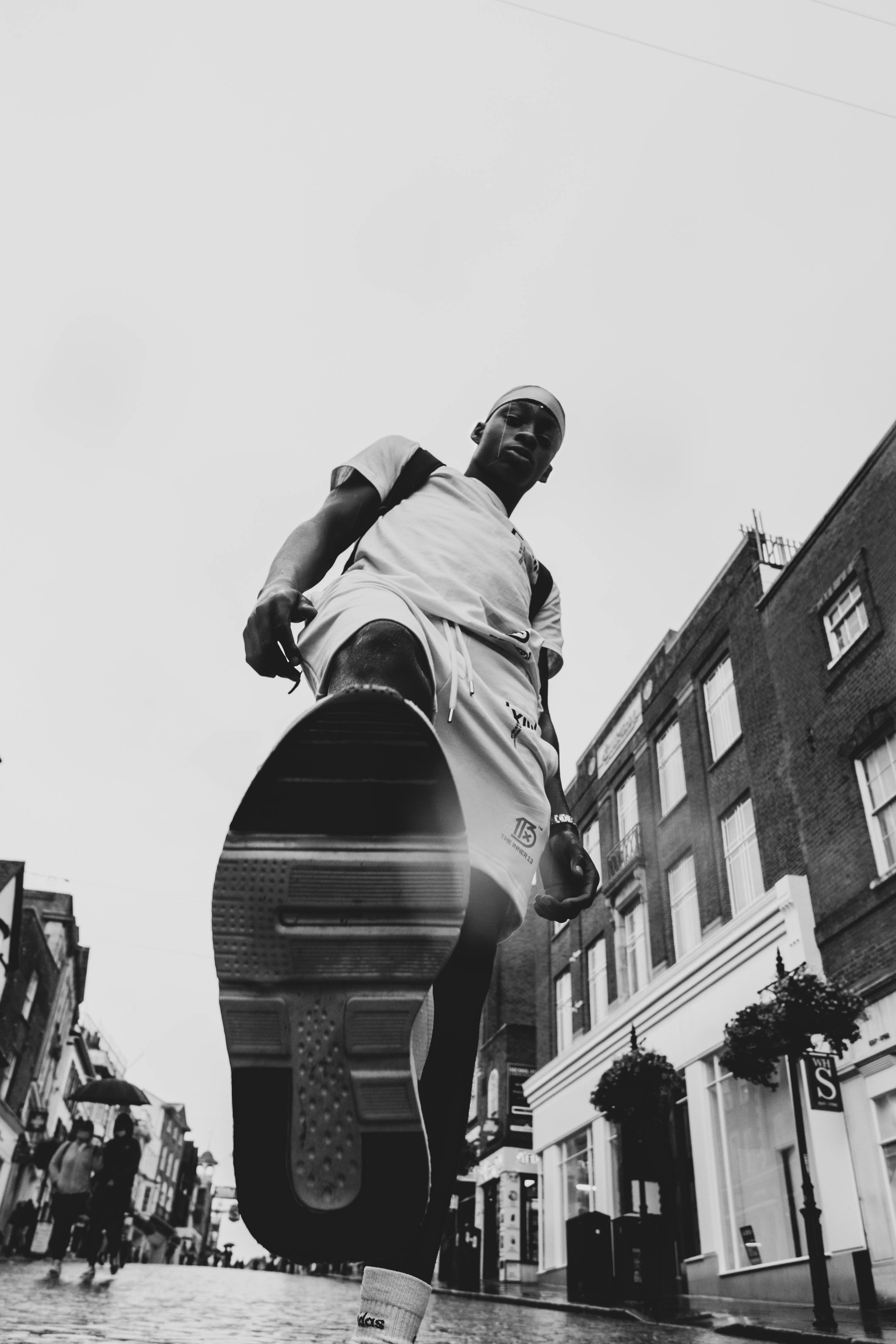 A Low Angle Shot of a Man Showing His Shoe Sole · Free Stock Photo
