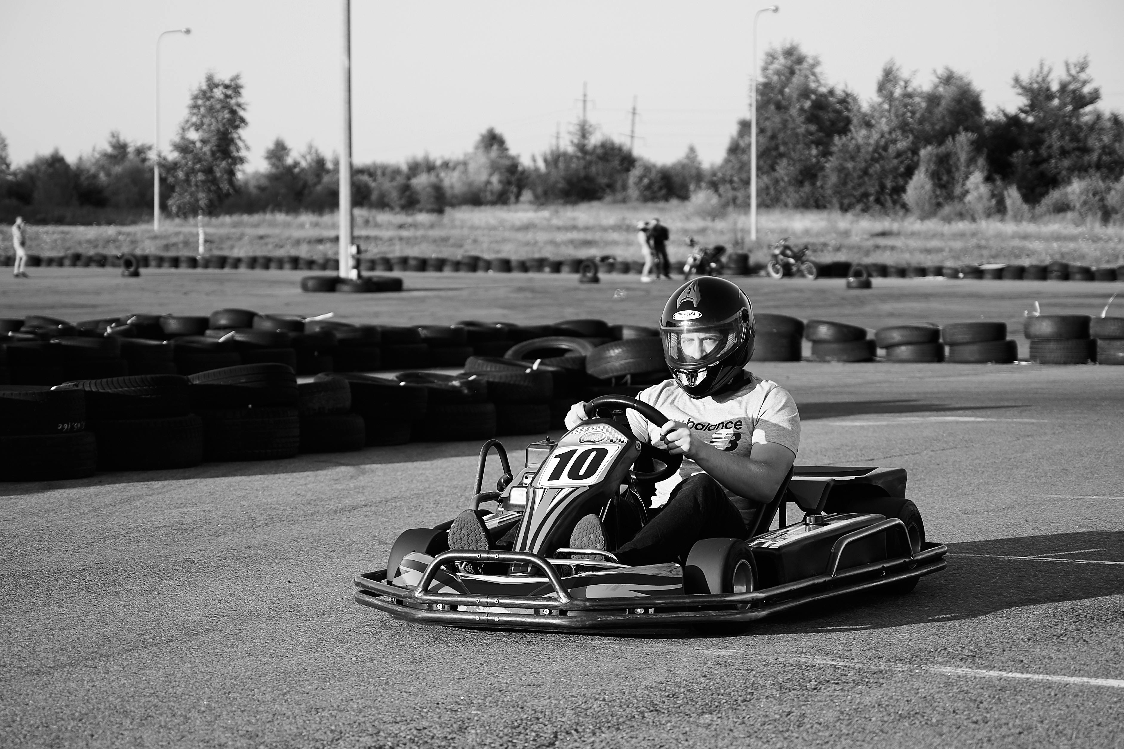 Grayscale Photograph of a Man Riding a Go-Kart · Free Stock Photo