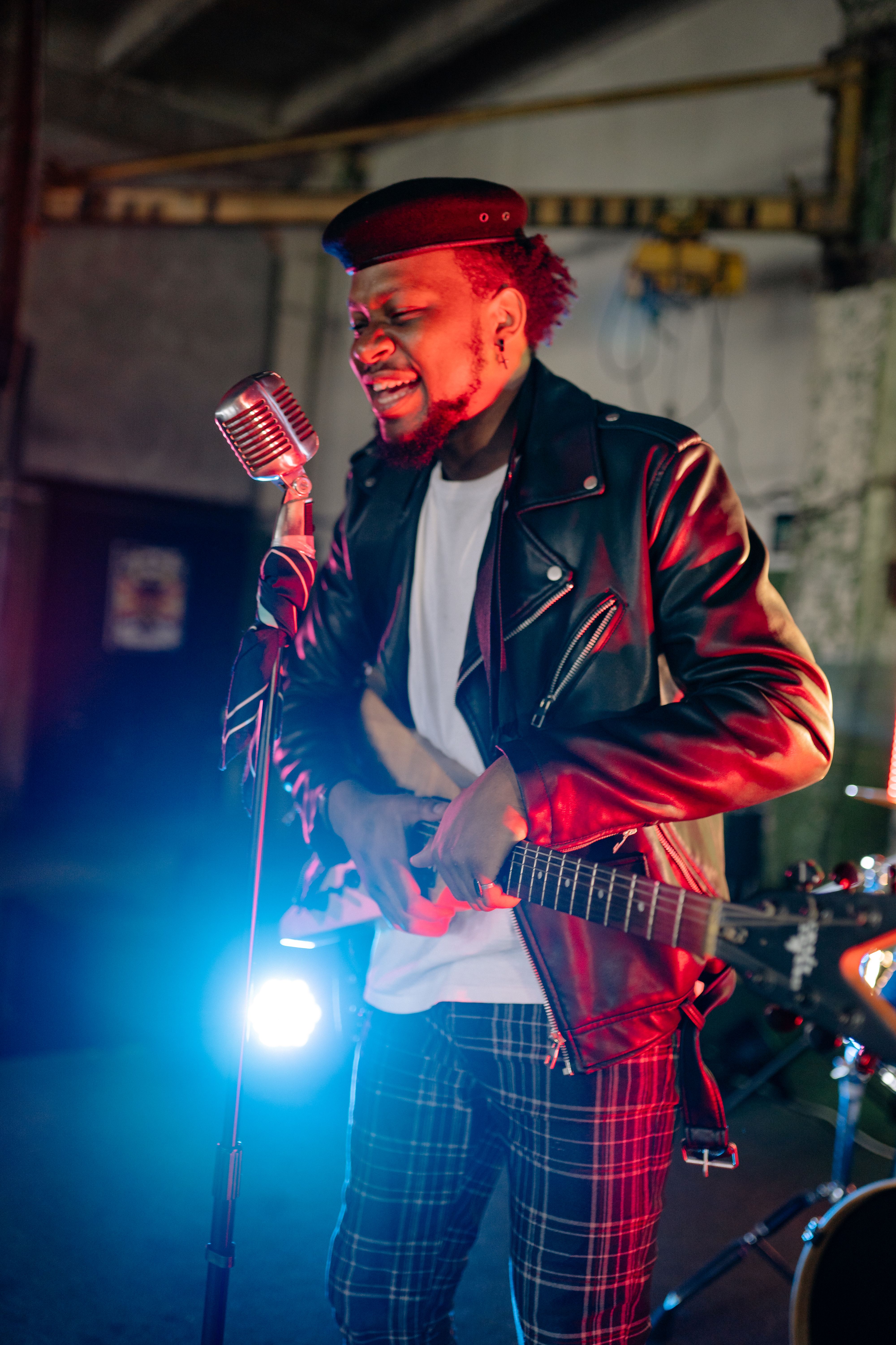 A Man in a Leather Jacket Singing · Free Stock Photo