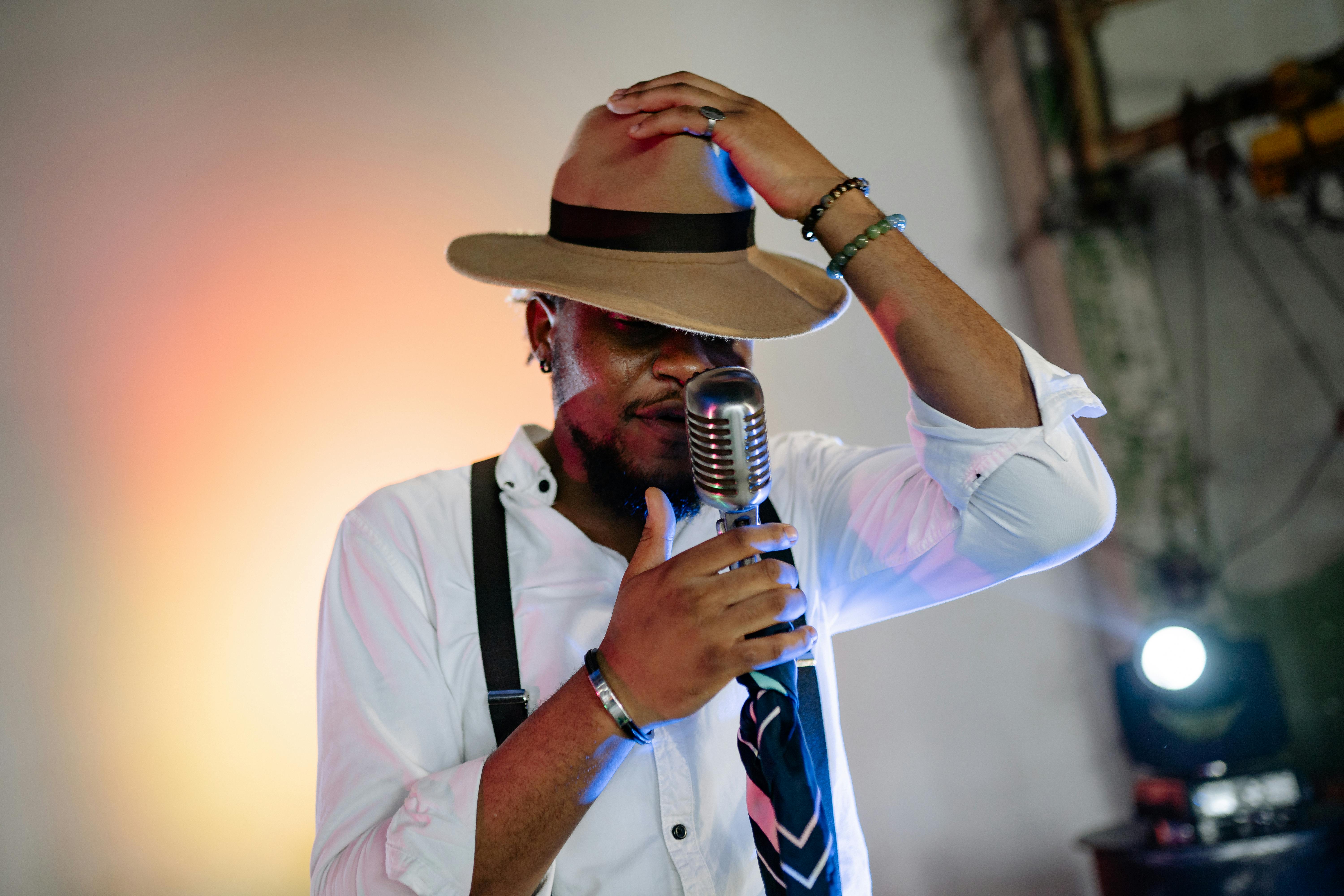 Photograph of a Singer Holding a Microphone · Free Stock Photo