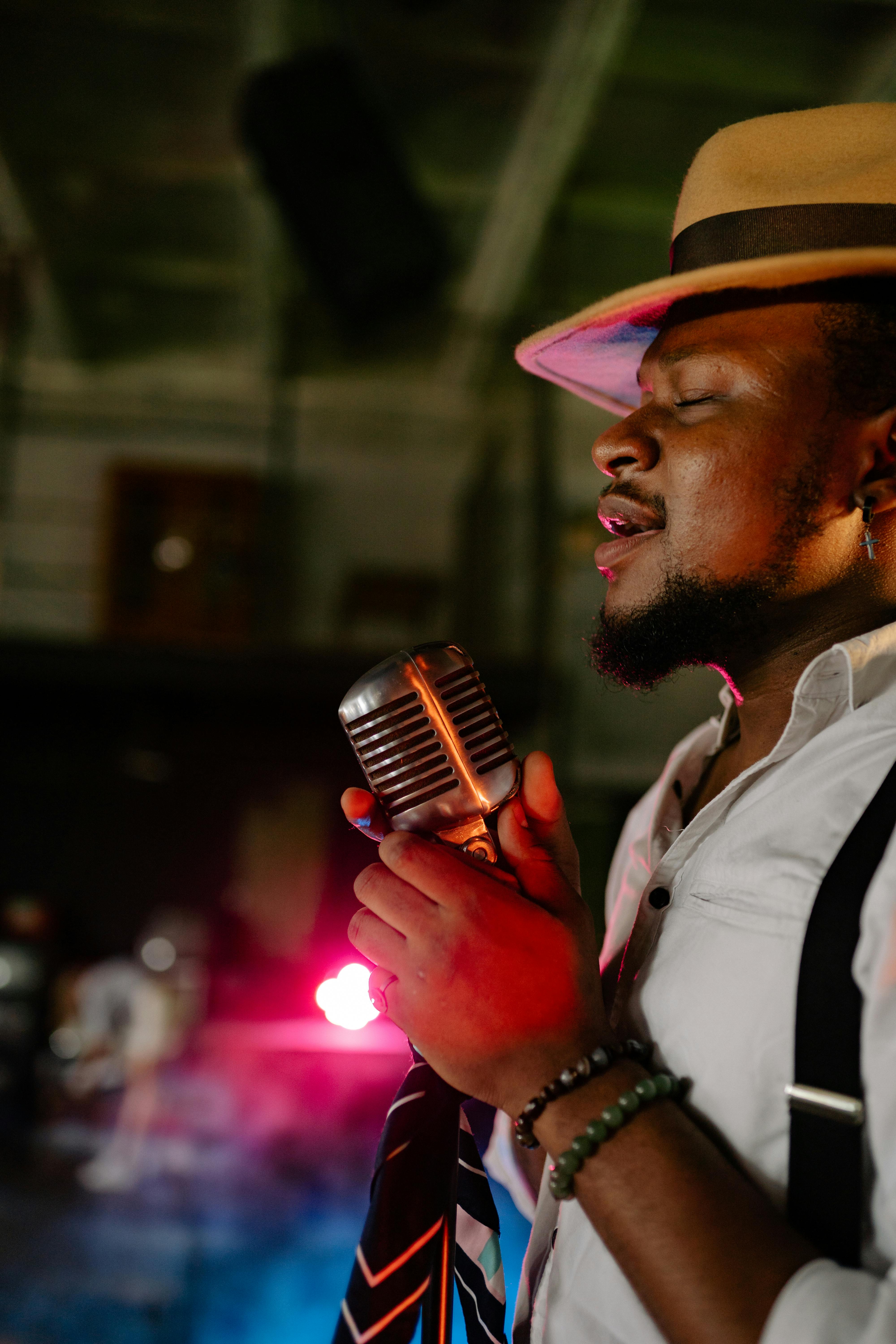 Man Holding Microphone Singing · Free Stock Photo