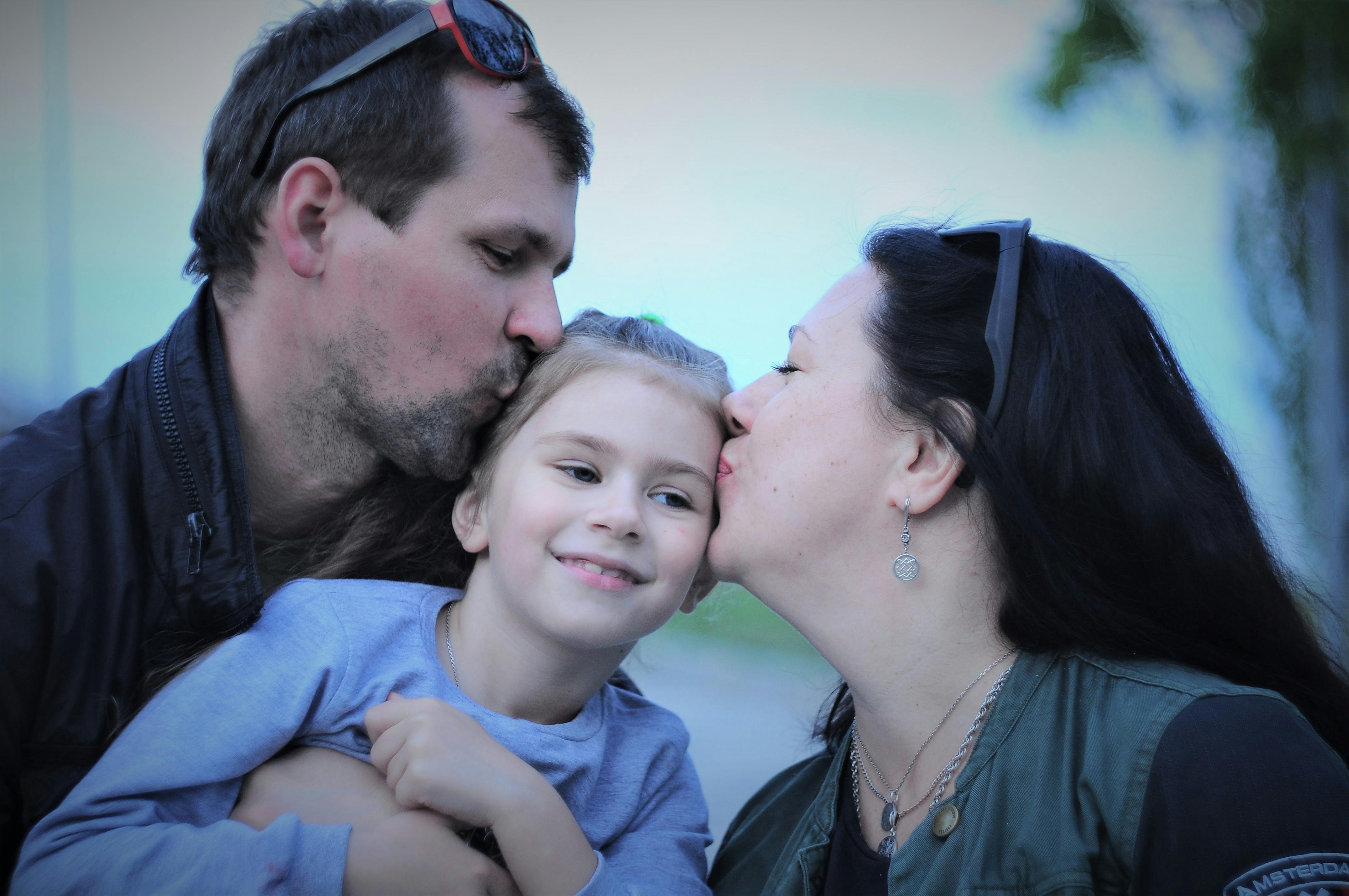 A Boy Hugging His Parents · Free Stock Photo